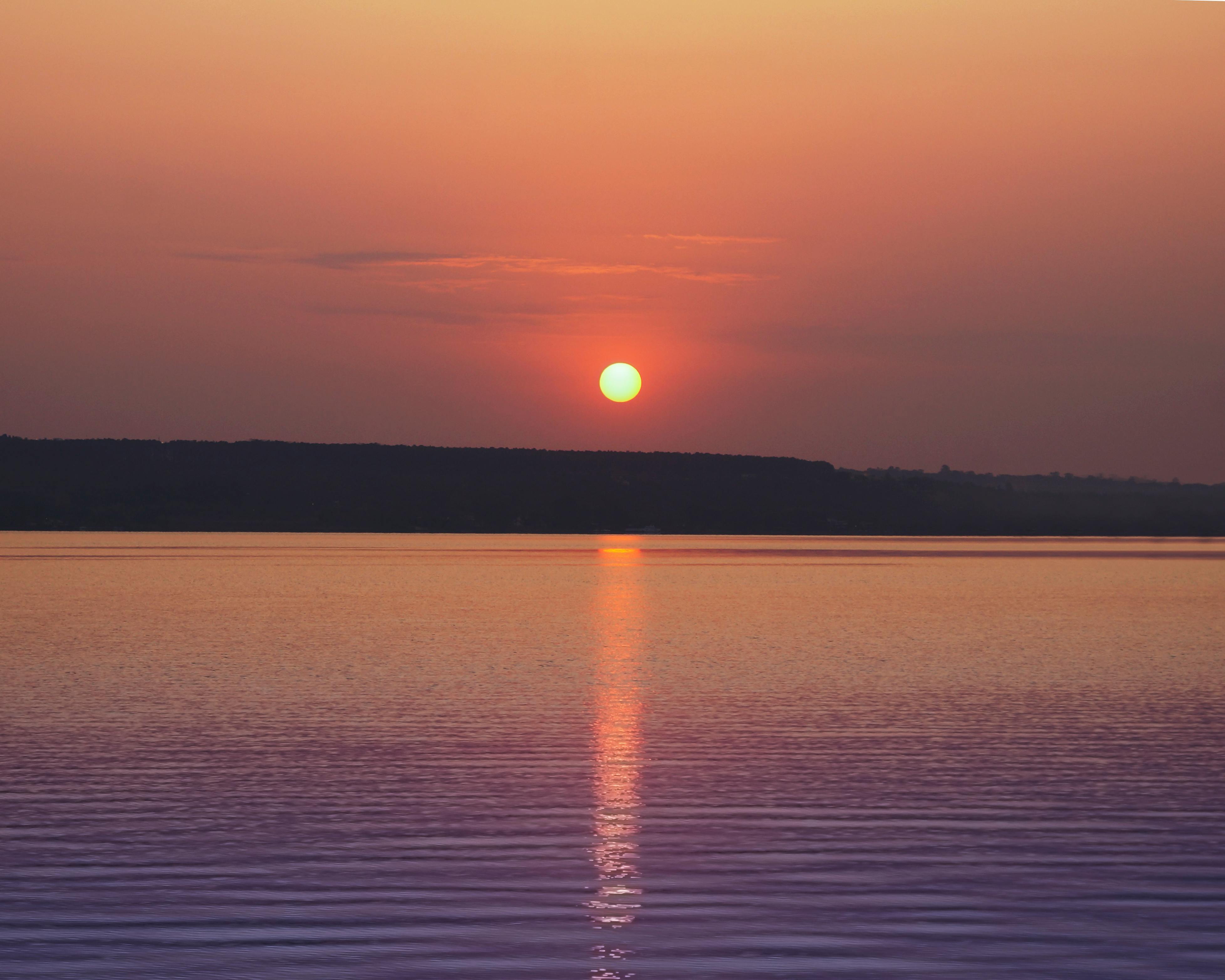 Sun on Clear Sky over Sea Shore at Sunset · Free Stock Photo