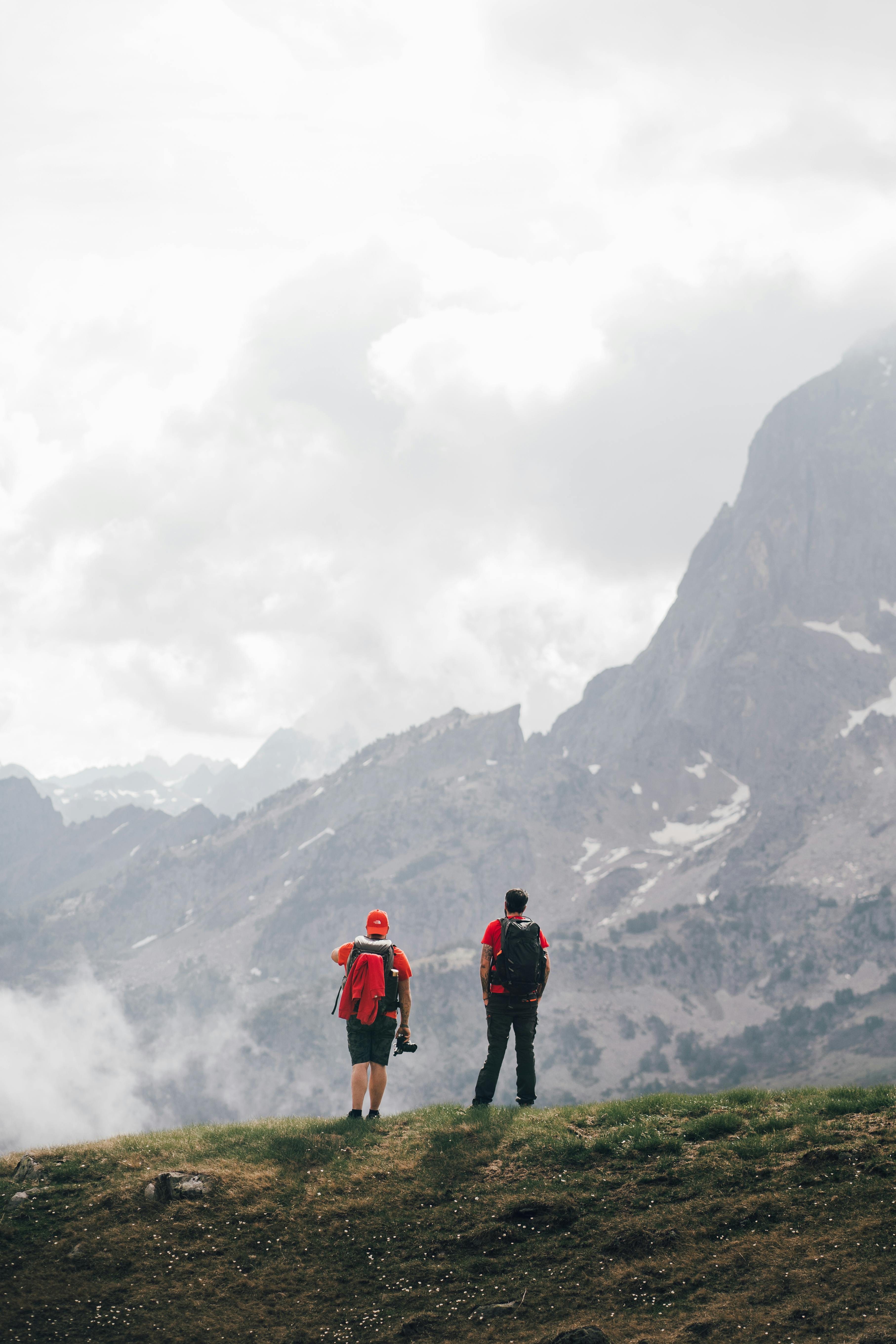 2 Person Standing Near the Mountain · Free Stock Photo