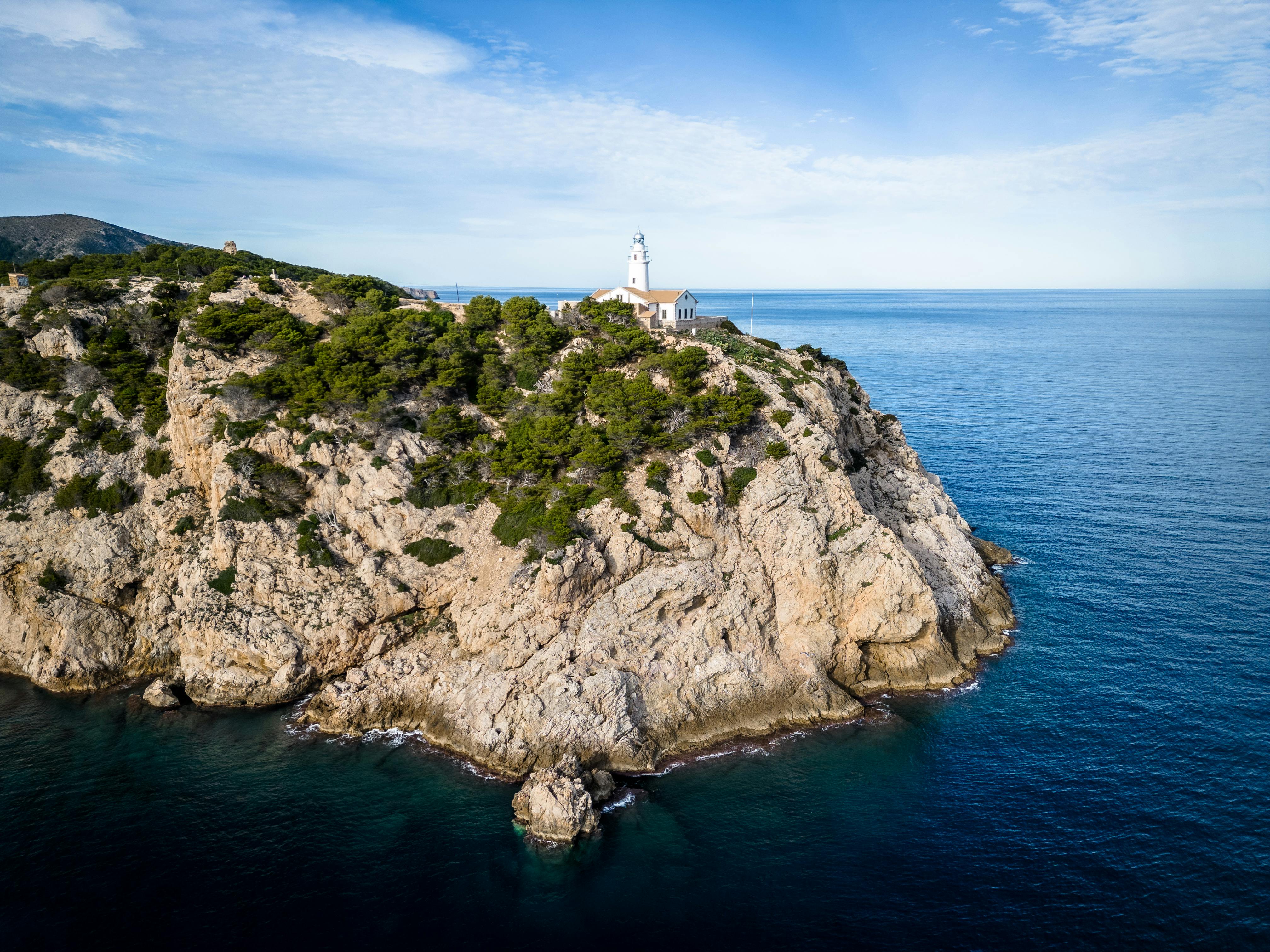 Photo of a Lighthouse on a Cliff · Free Stock Photo