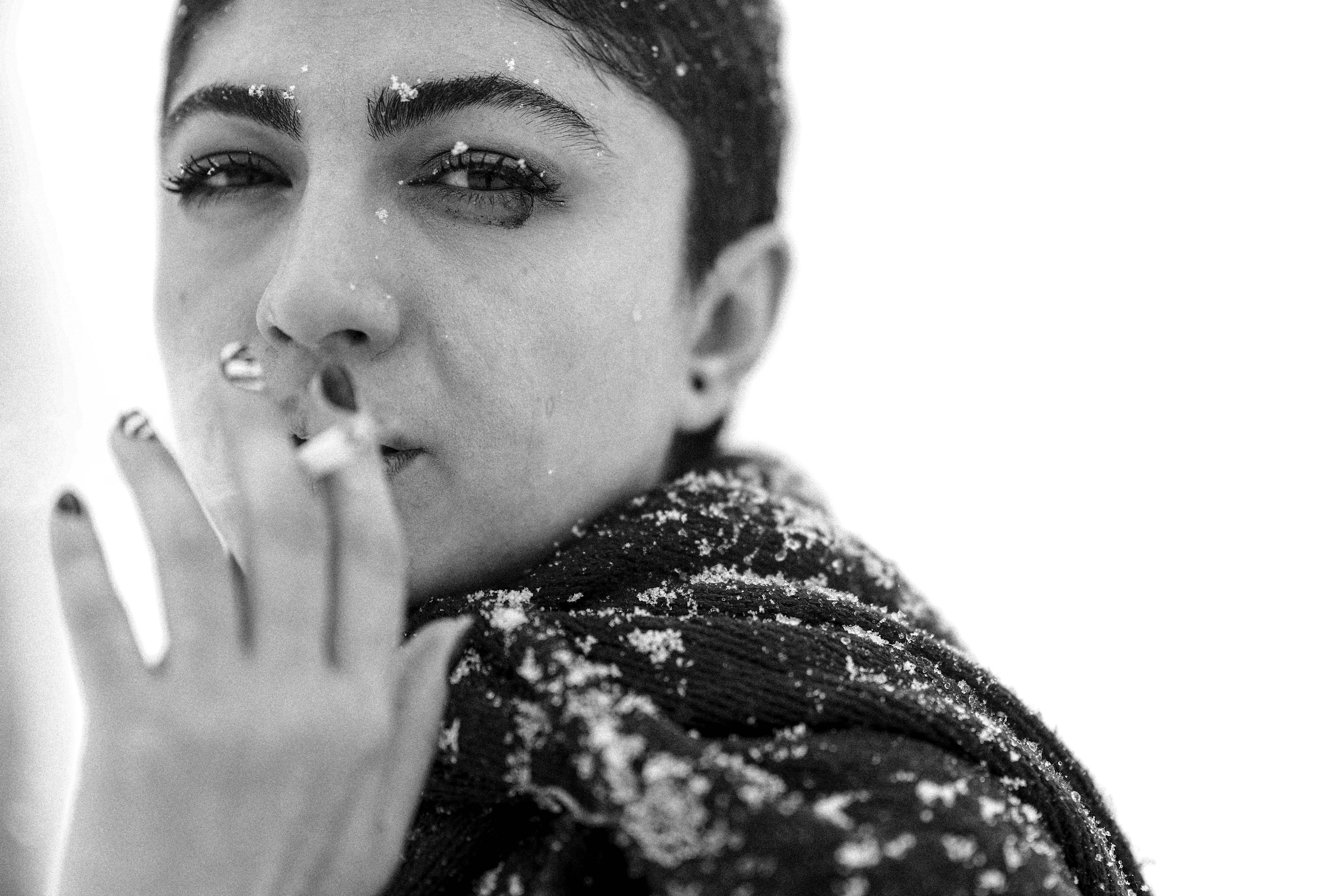 Close Up of a Woman Smoking a Cigarette · Free Stock Photo