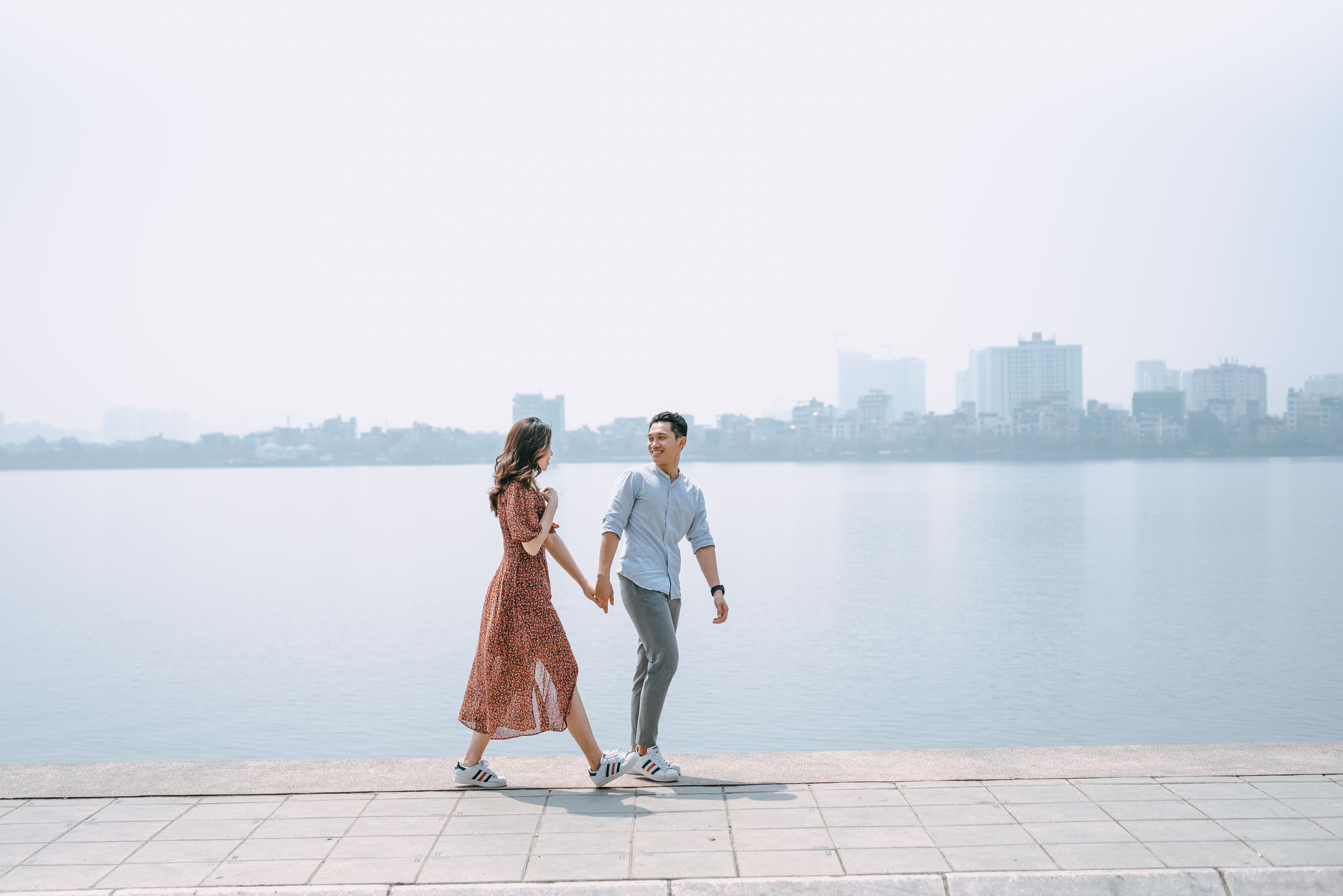 Couple Walking on Promenade by Lake in City · Free Stock Photo
