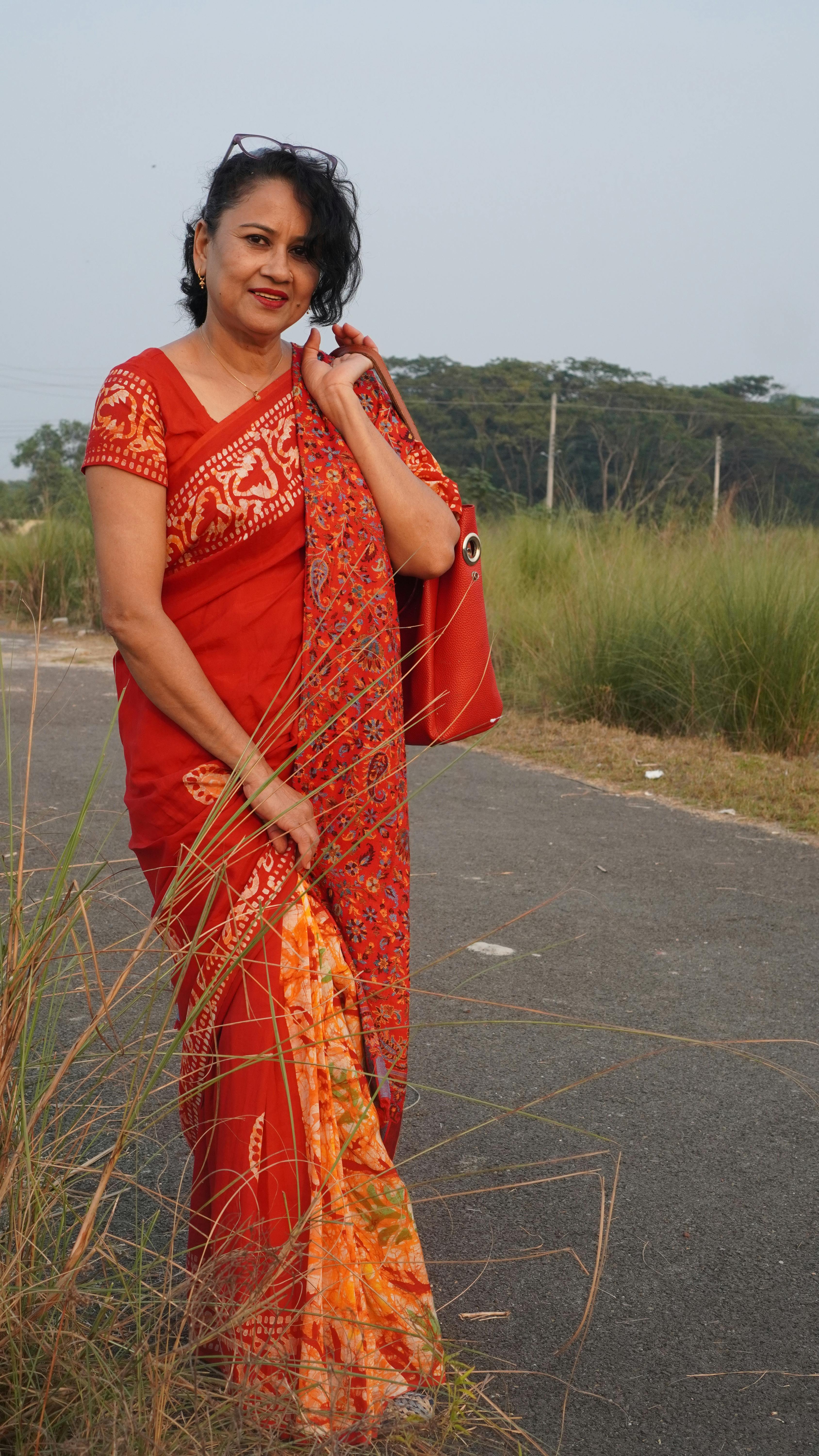 Woman in Red Traditional Clothing Standing on the Road · Free Stock Photo