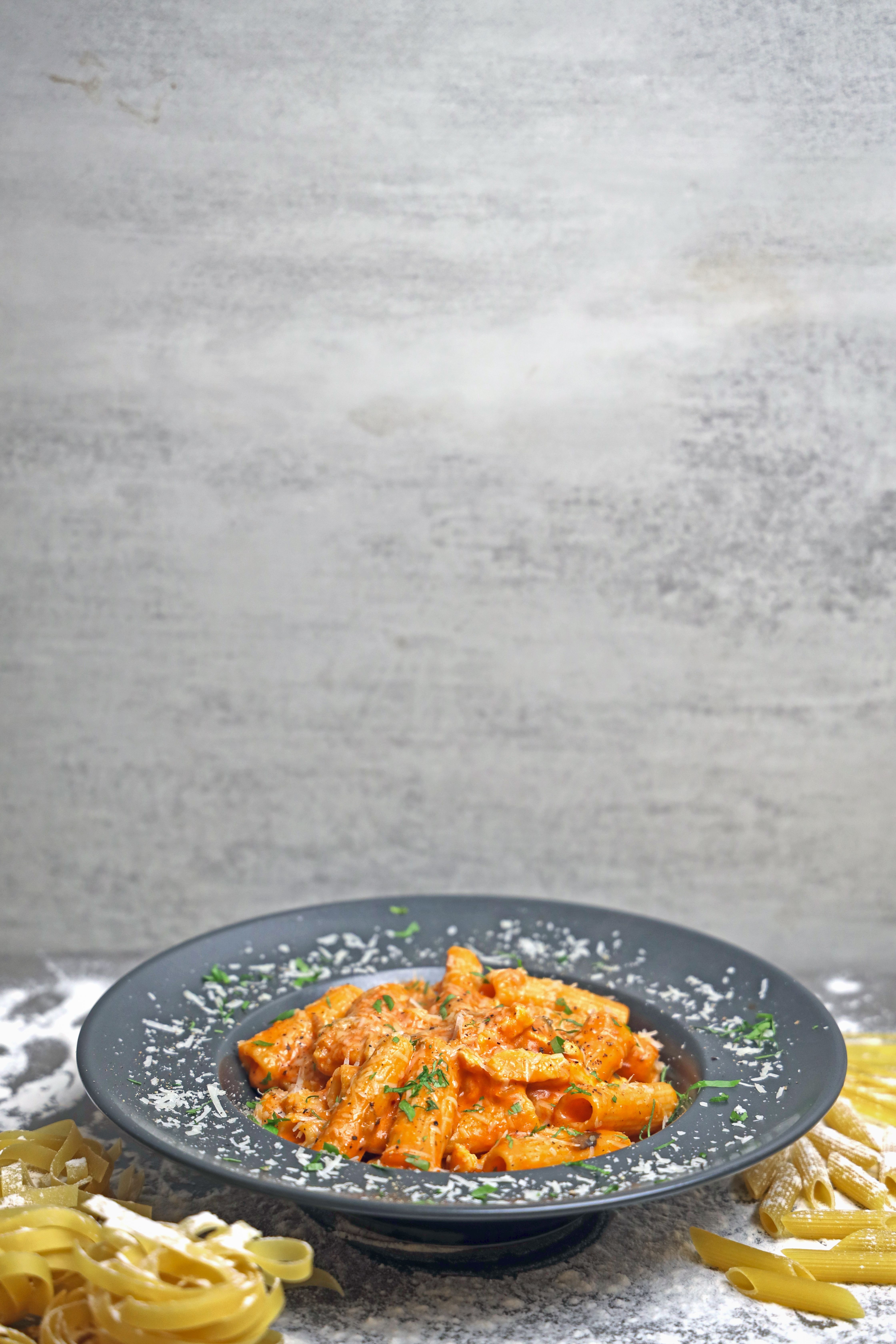 A plate of pasta with sauce and cheese · Free Stock Photo