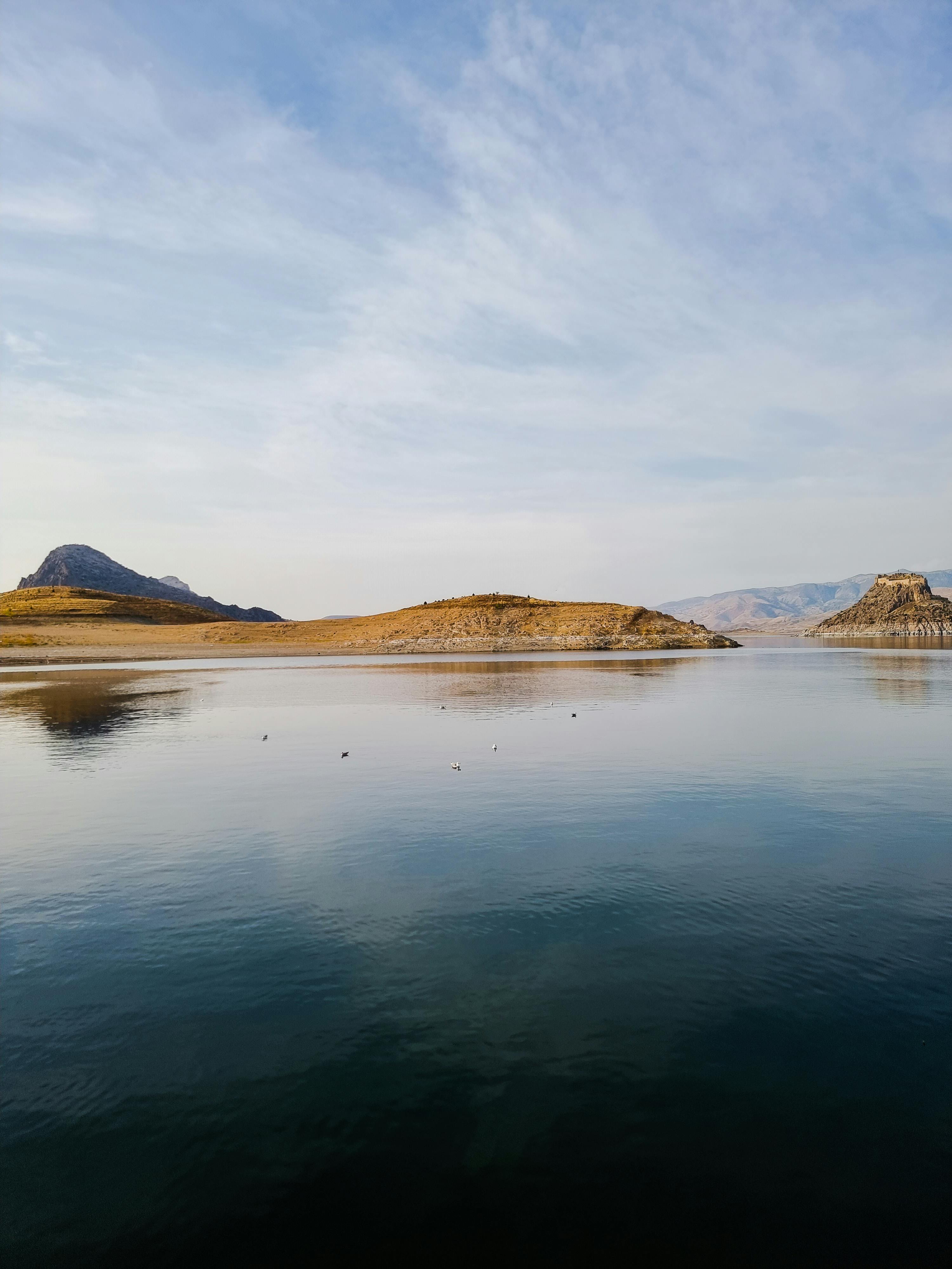 Clouds Above Lake and Rocks · Free Stock Photo