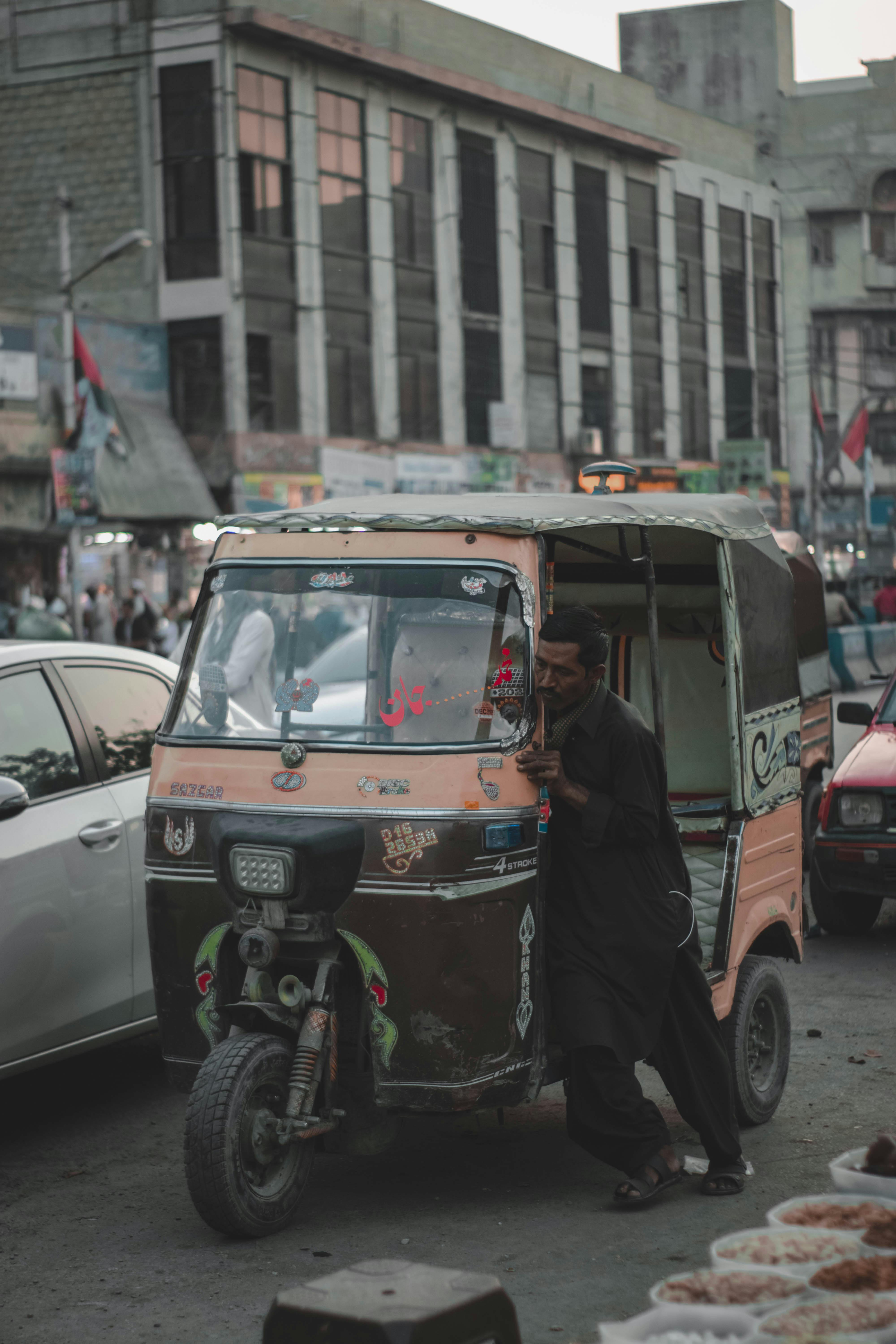 Man Pushing an Auto Rickshaw · Free Stock Photo