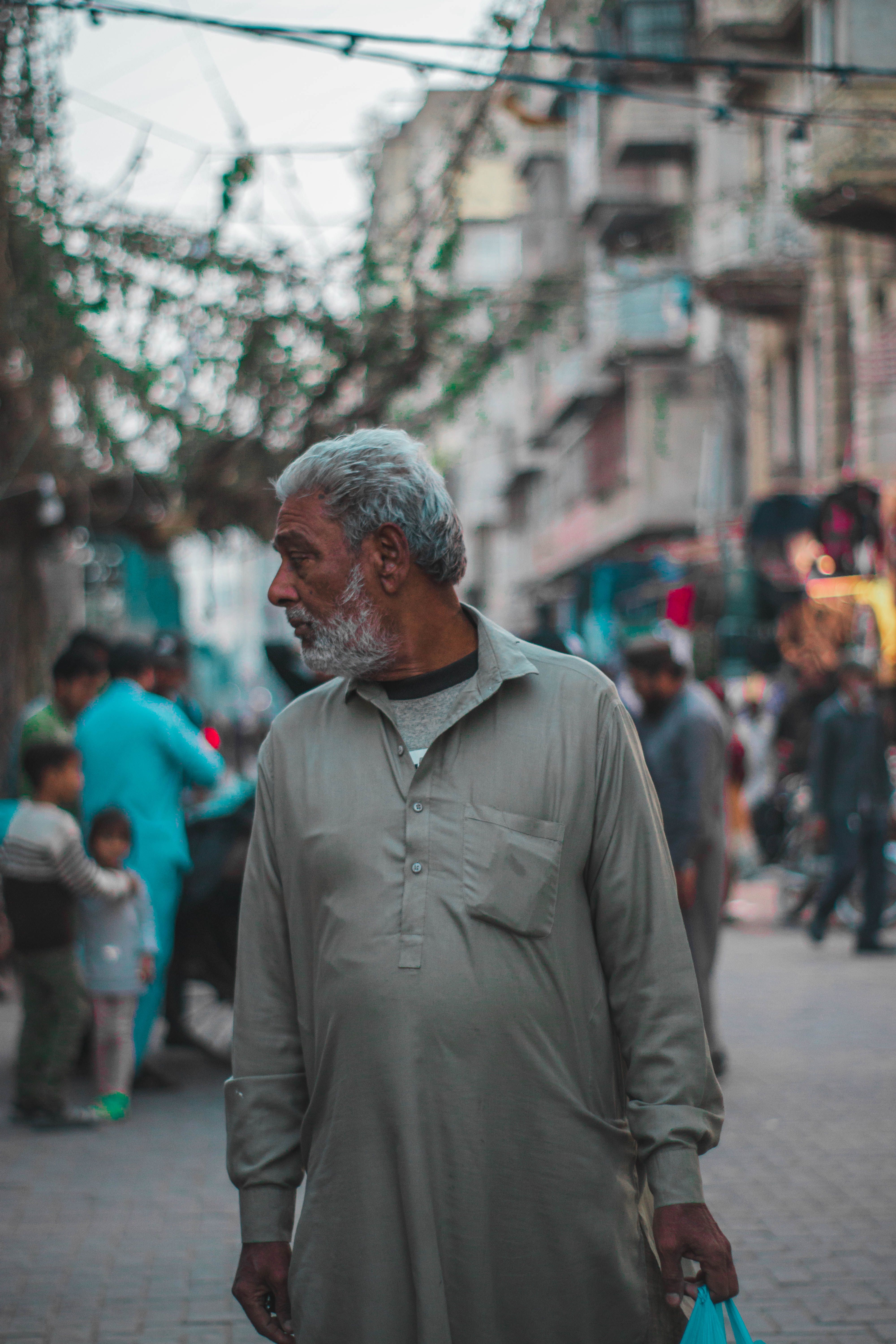 Bearded Man Wearing a Thobe Walking on the Street · Free Stock Photo