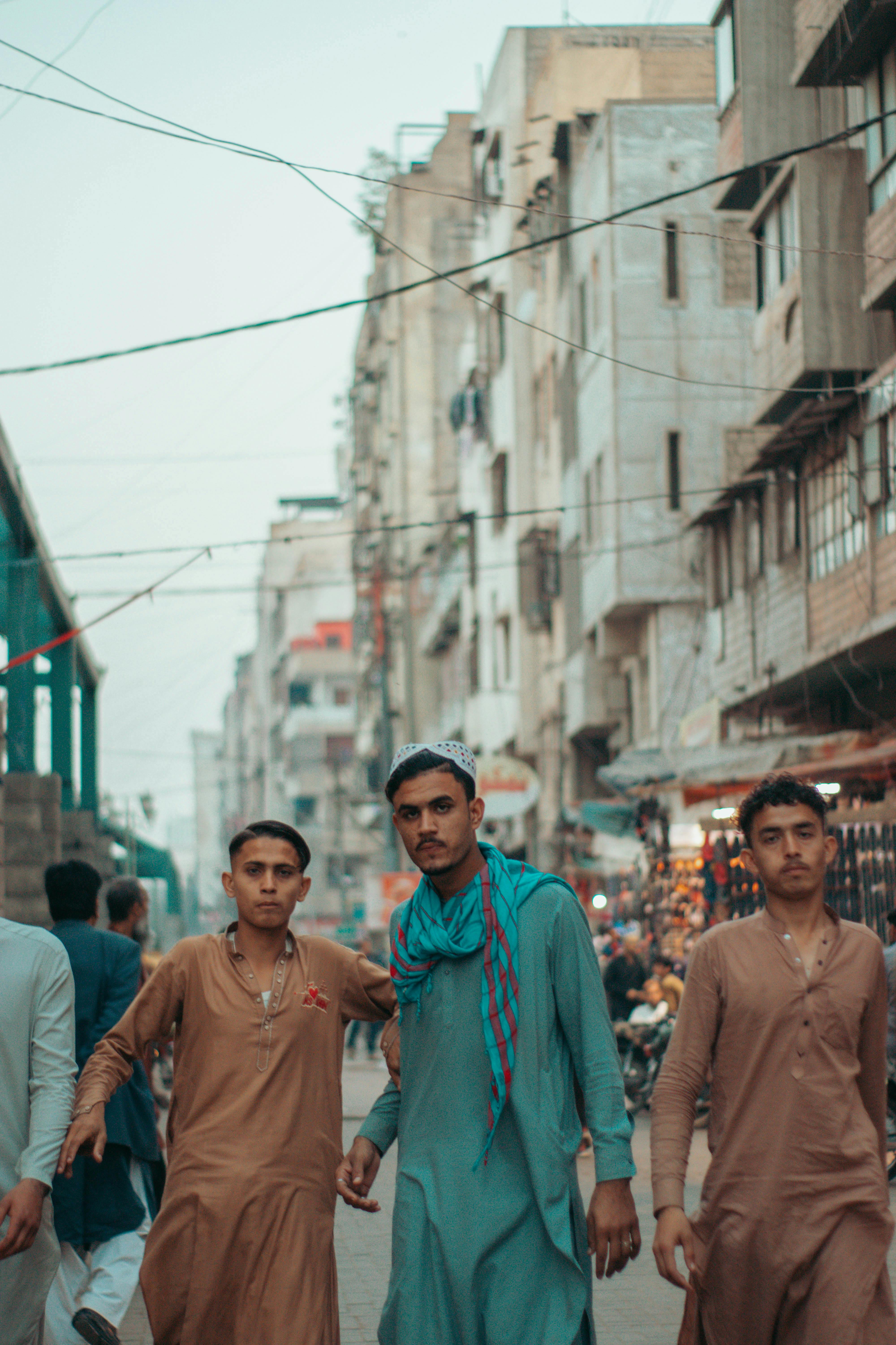 Men in Traditional Clothes Walking on City Street · Free Stock Photo