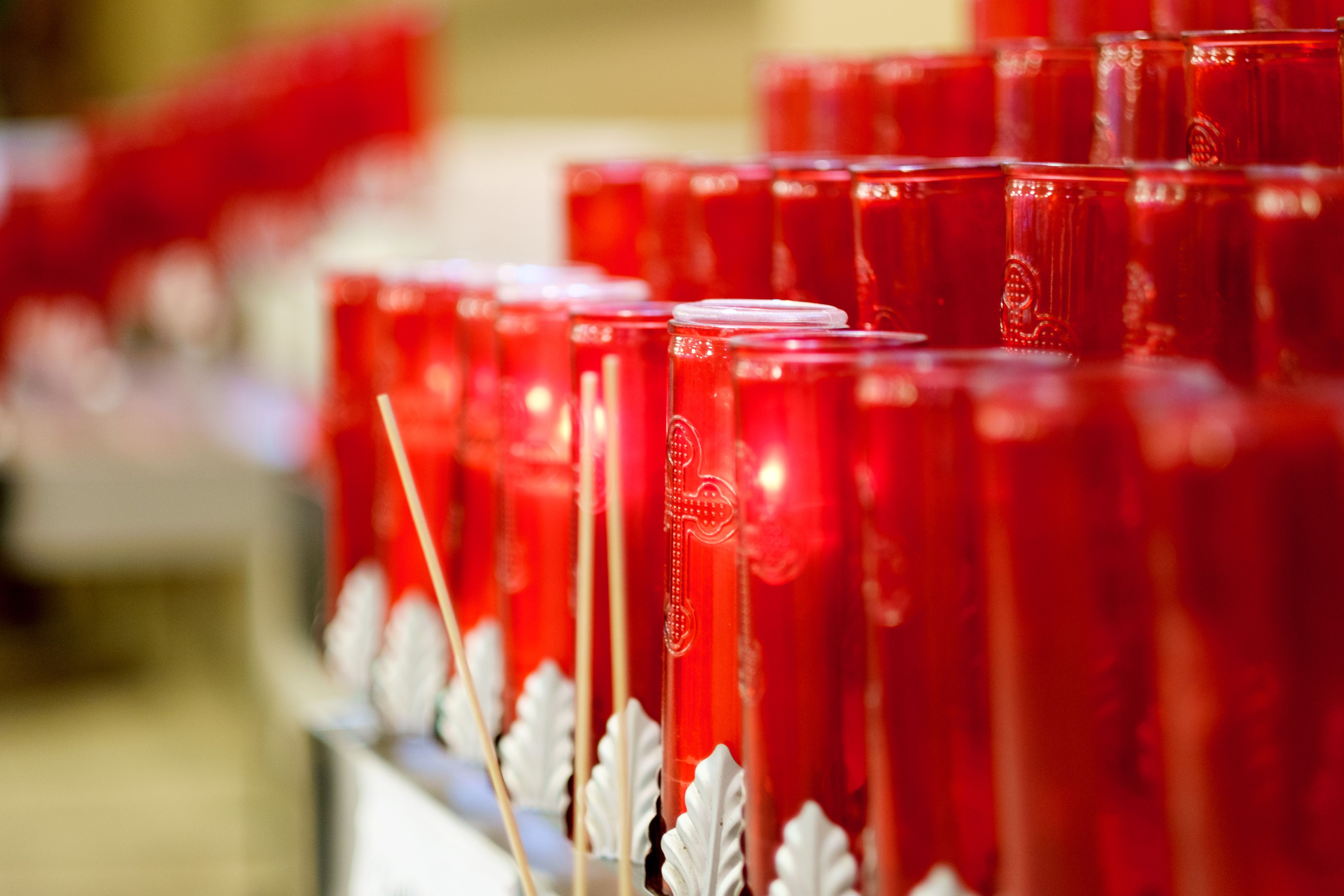 Incense Sticks and Illuminated Candles in Red Containers · Free Stock Photo