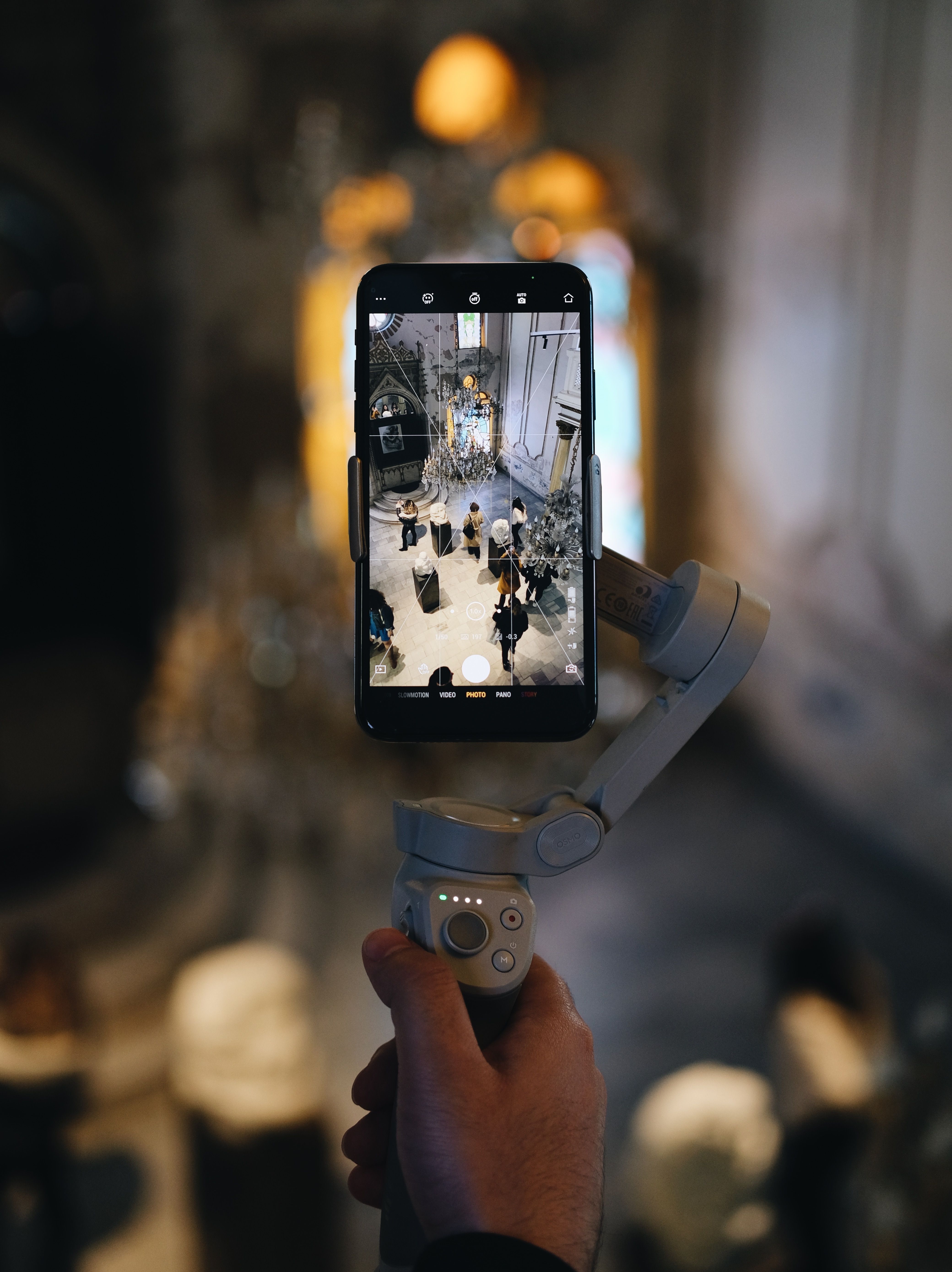 A Person Holding a Gimbal with an Attached Smartphone · Free Stock Photo