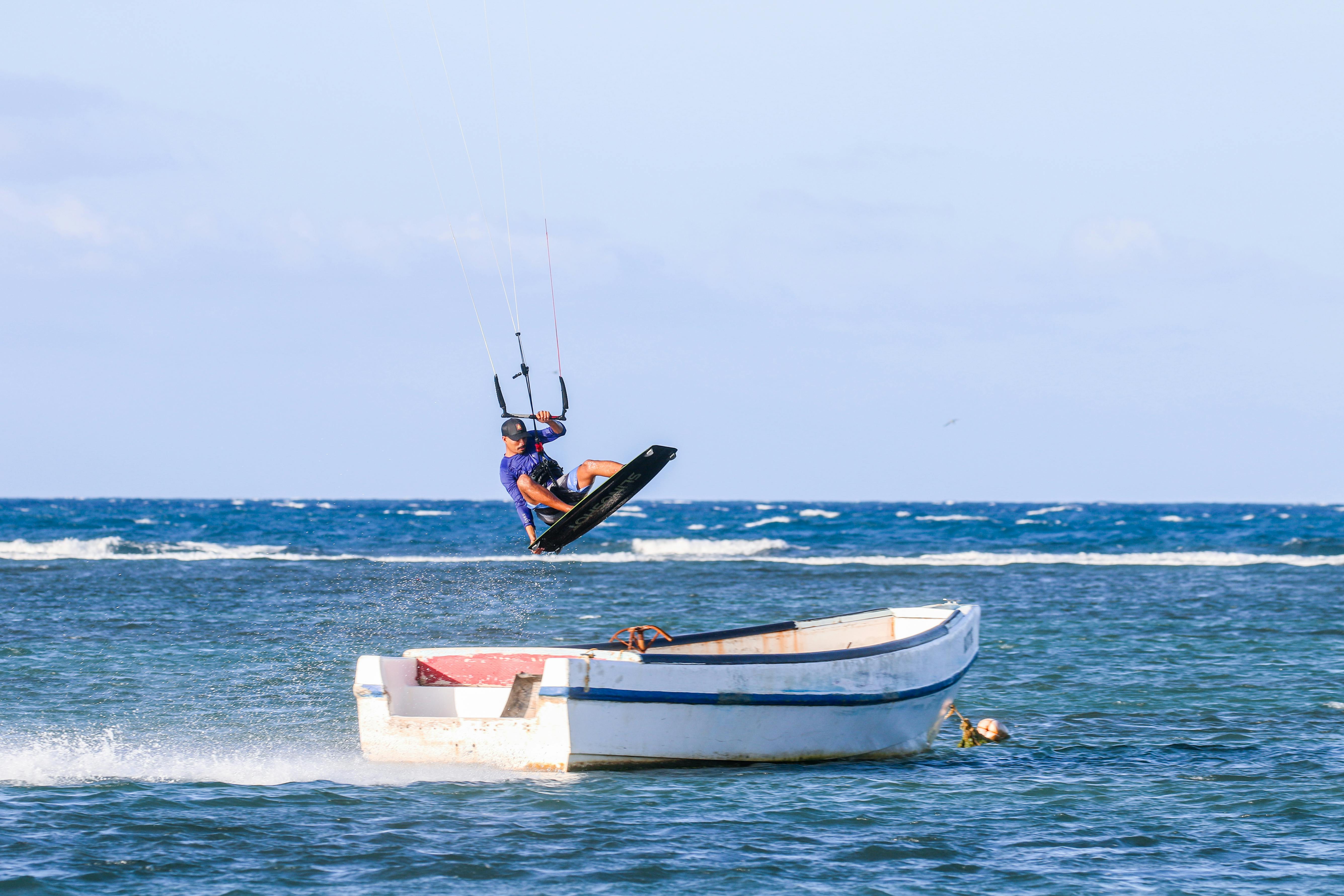 Person Carrying a Kite and a Surfboard · Free Stock Photo