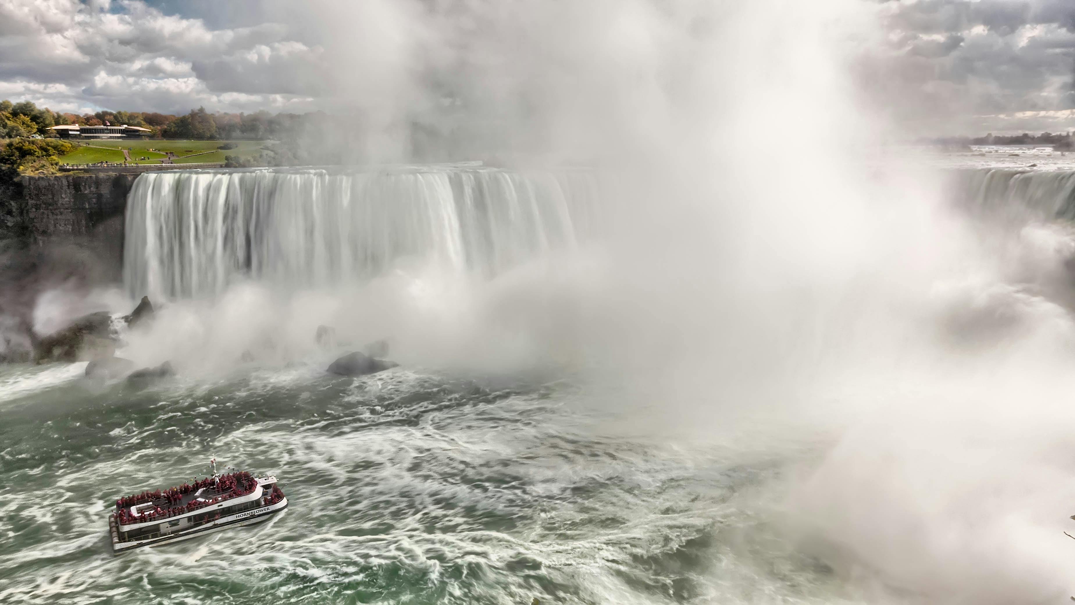 Boat Near Waterfalls during Daytime · Free Stock Photo