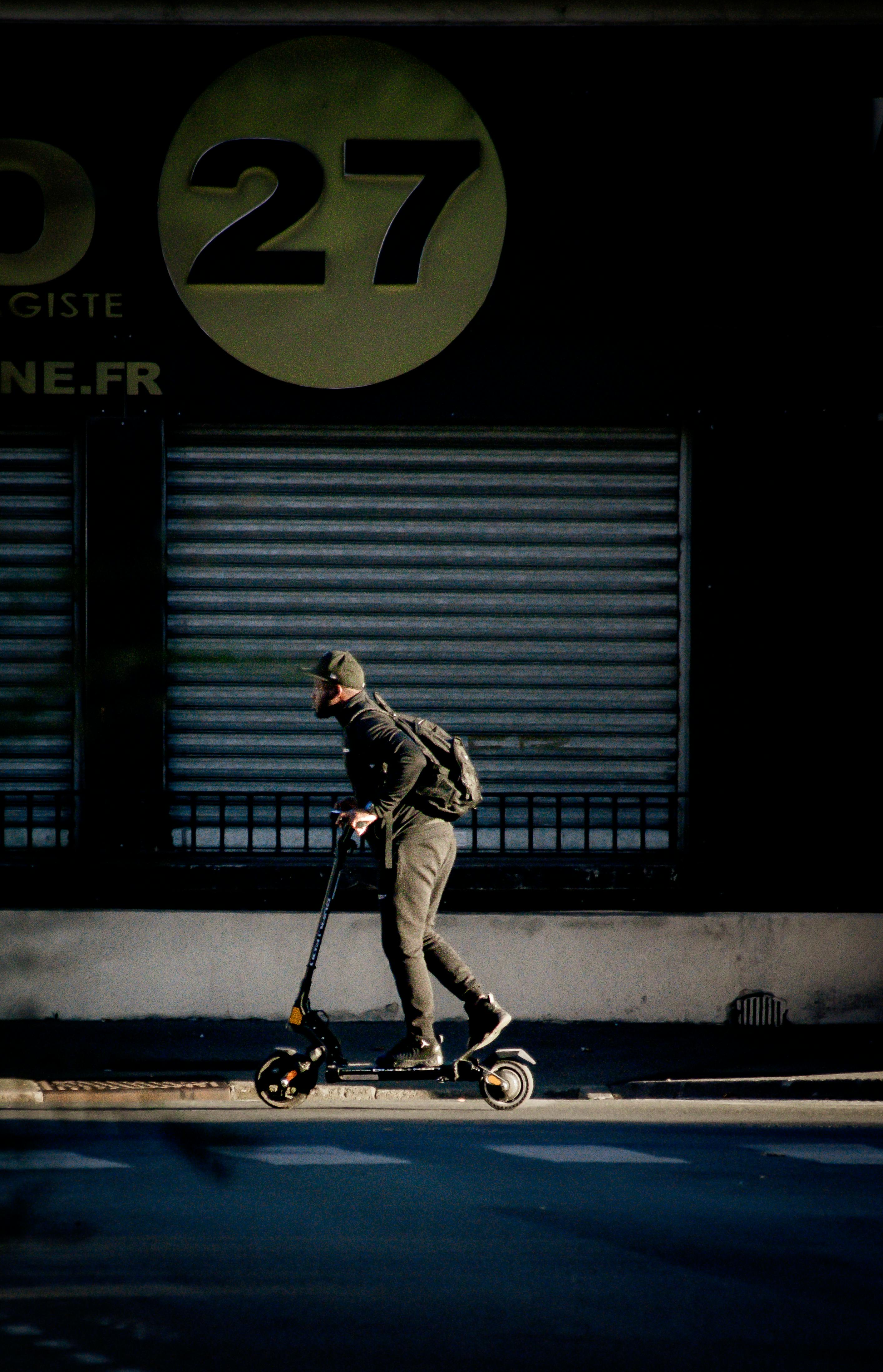 Side View of a Man Riding Electric Scooter · Free Stock Photo