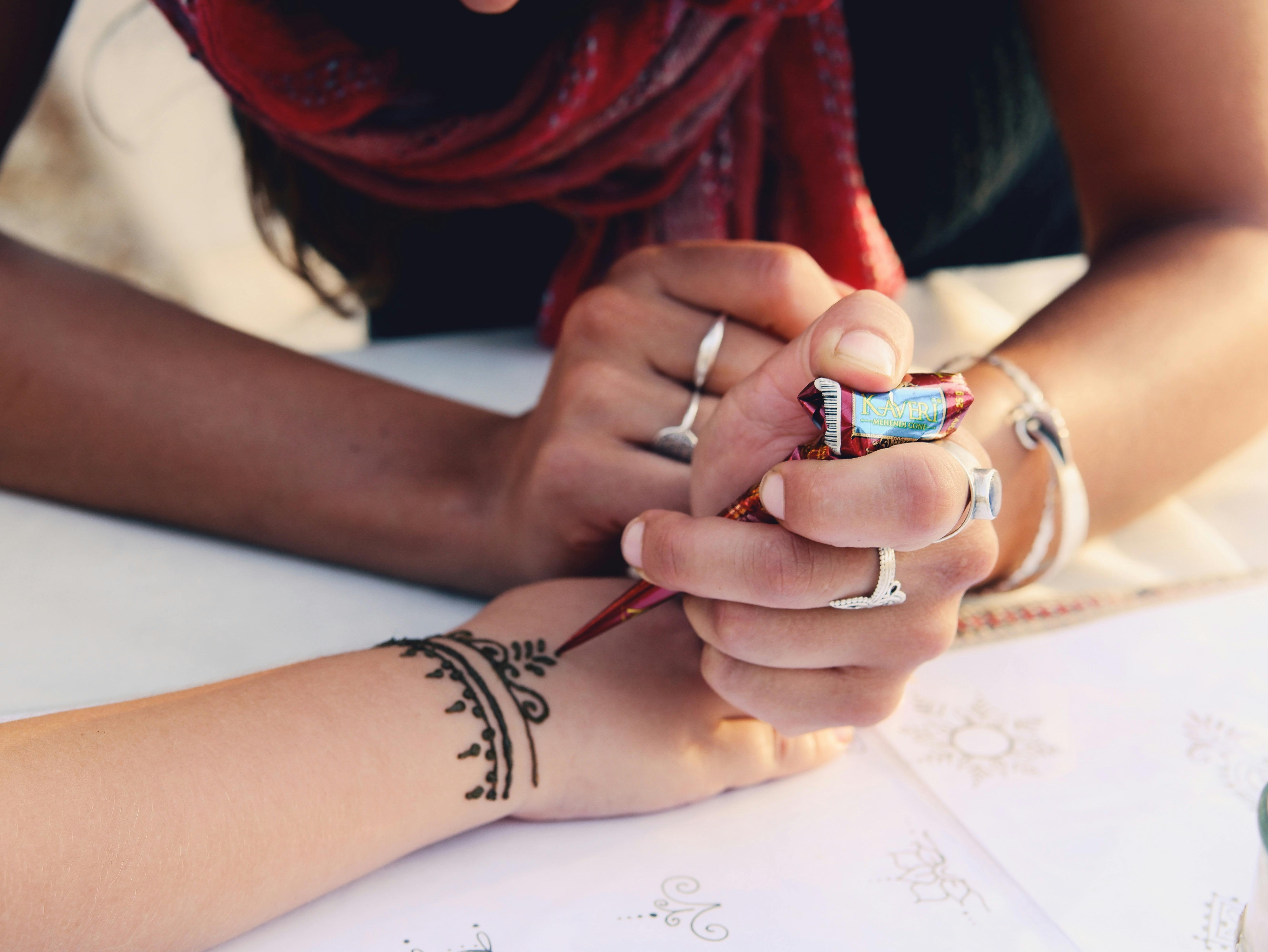 Woman Decorating Hand with Henna · Free Stock Photo