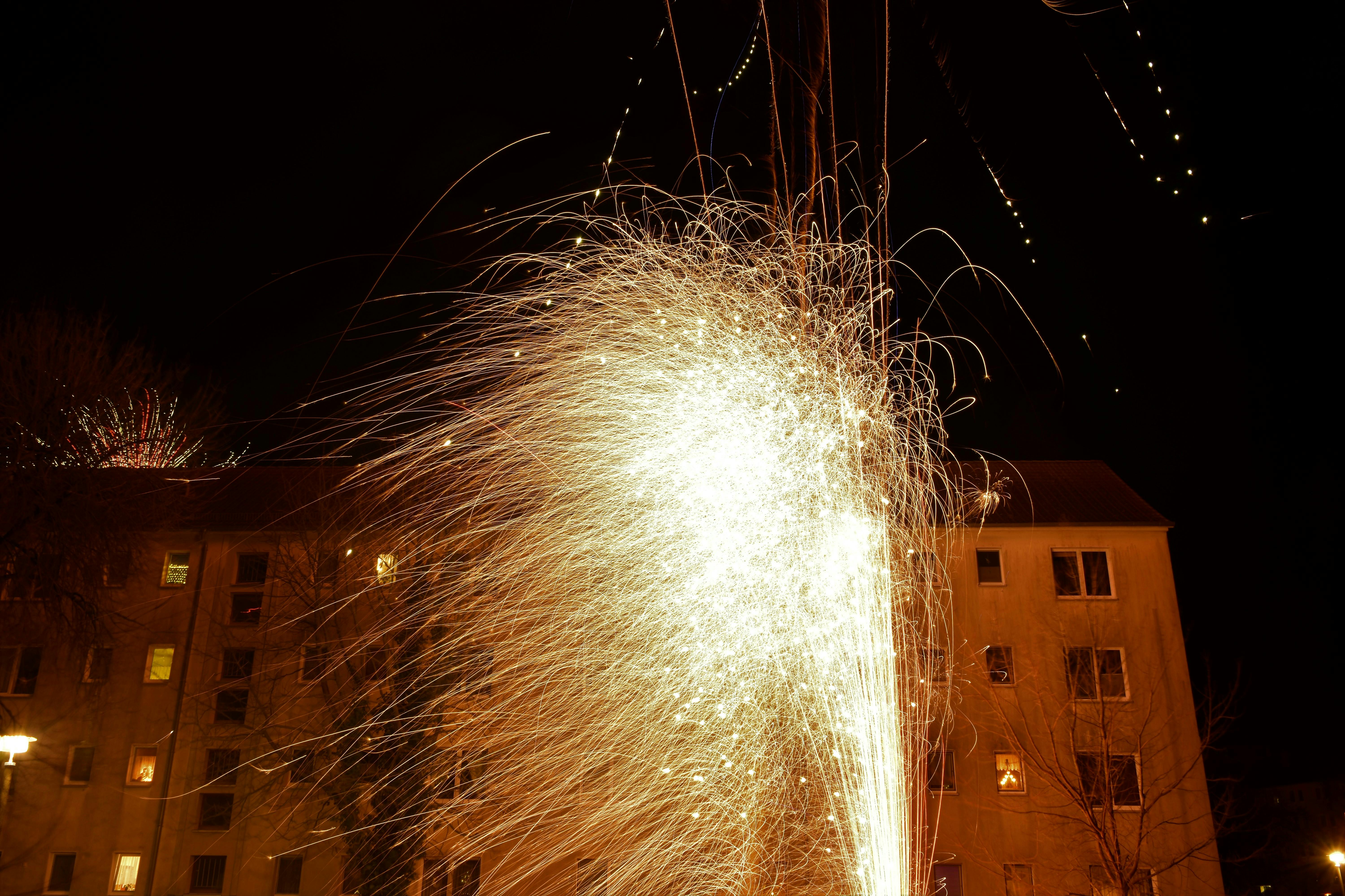 Fireworks Beside the Concrete Building · Free Stock Photo