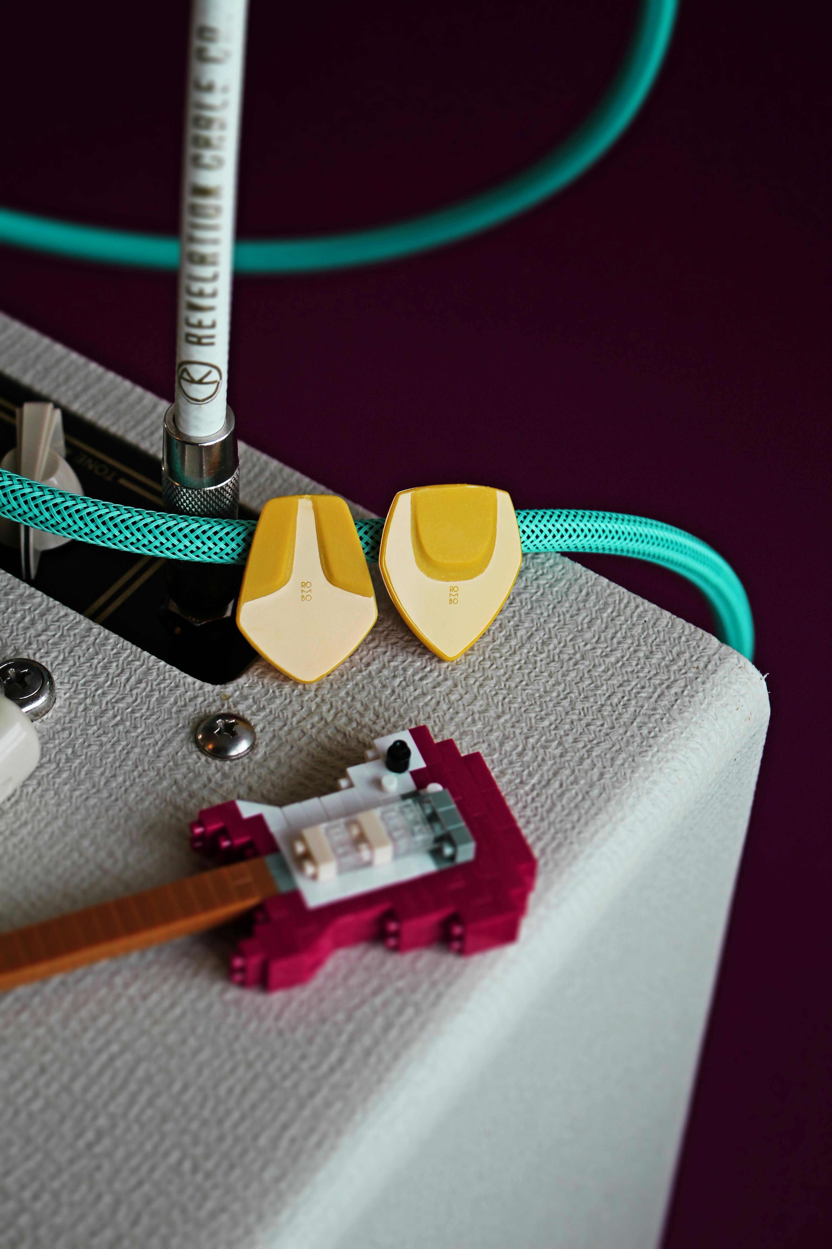 Toy Electric Guitar and Yellow Picks Lying on a Gray Amp Cabinet · Free ...