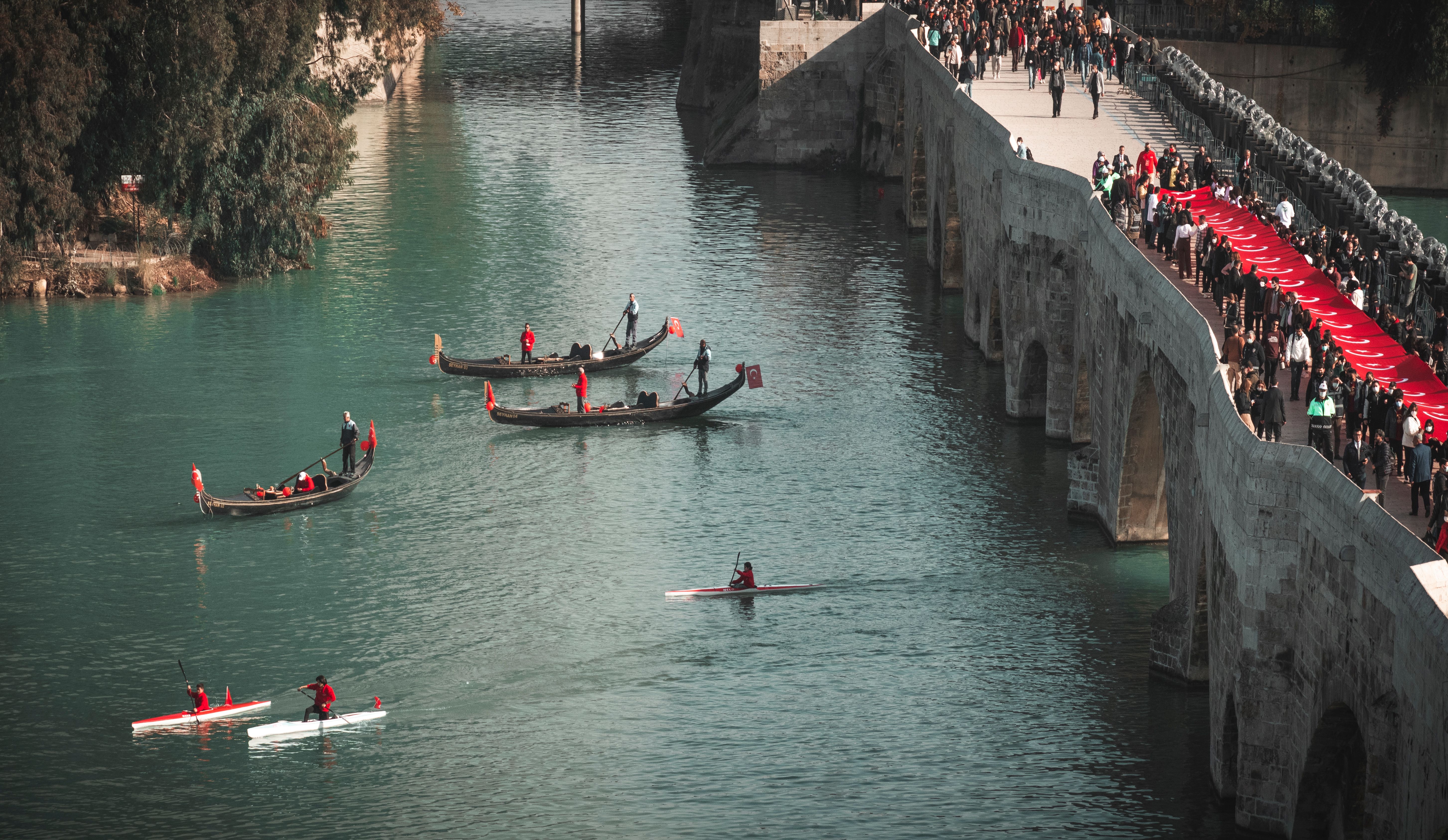 Aerial View of People in Boats and Marching through the Bridge with ...