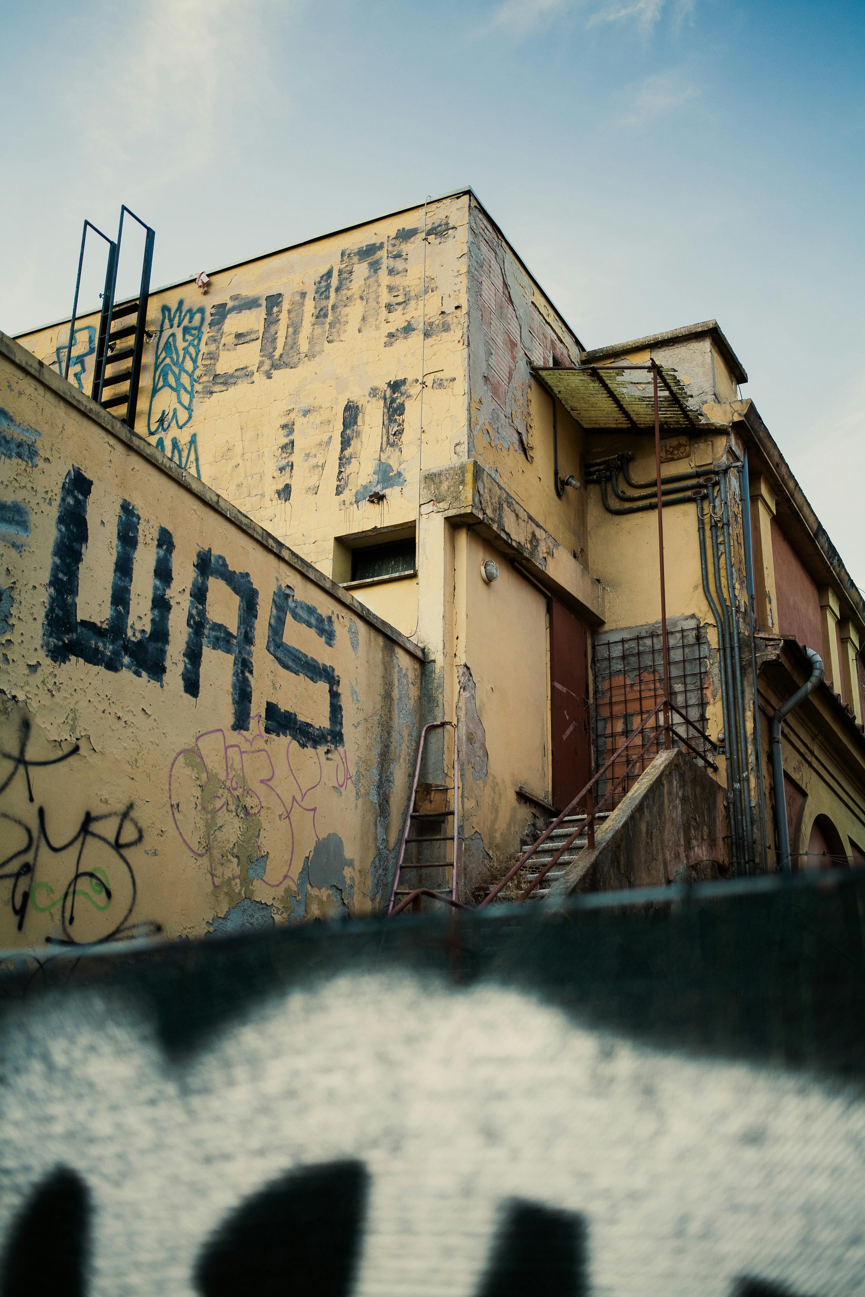 Exterior of a Building Covered in Graffiti · Free Stock Photo