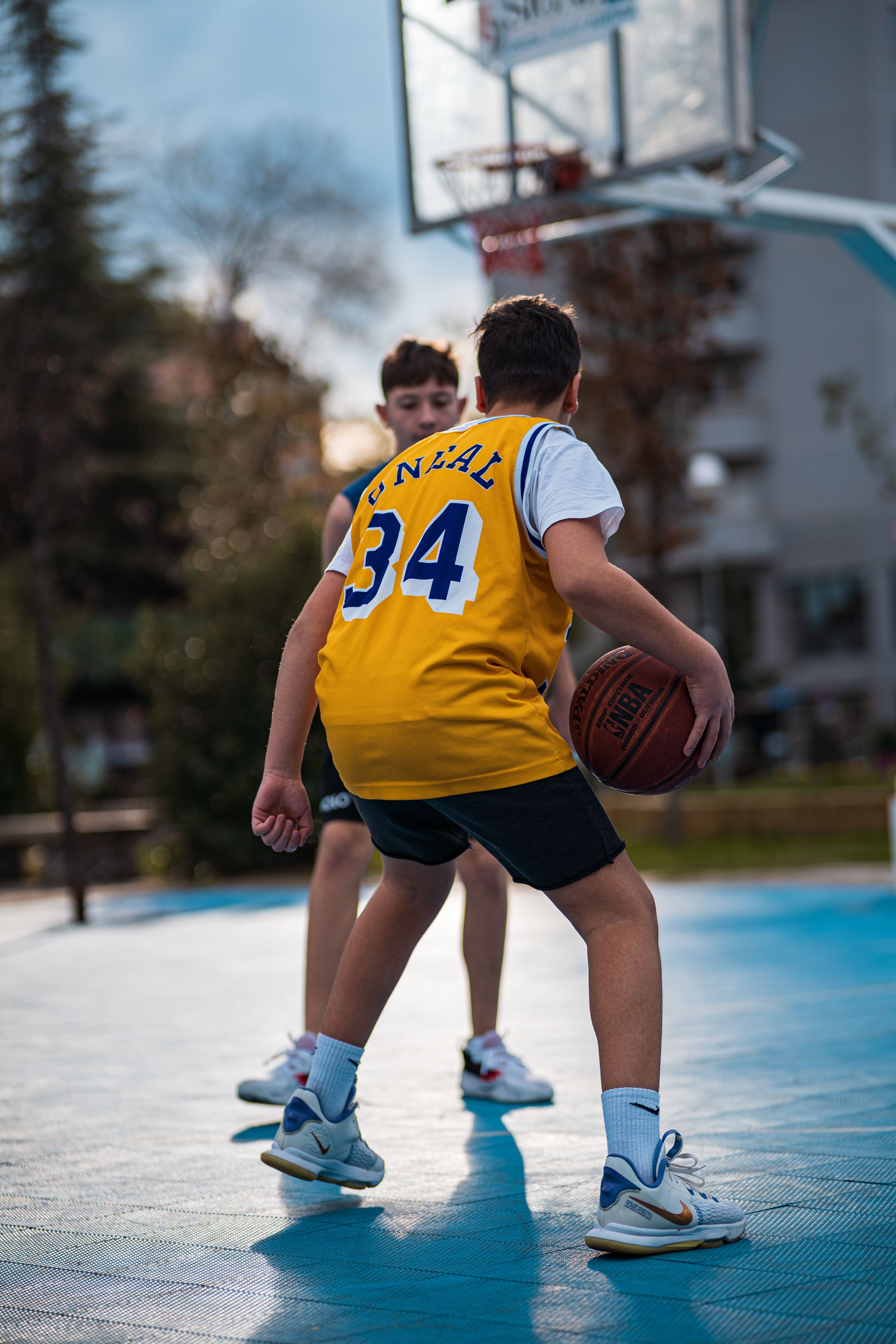 Man Dunking a Ball into the Basket on an Outdoor Basketball Court ...