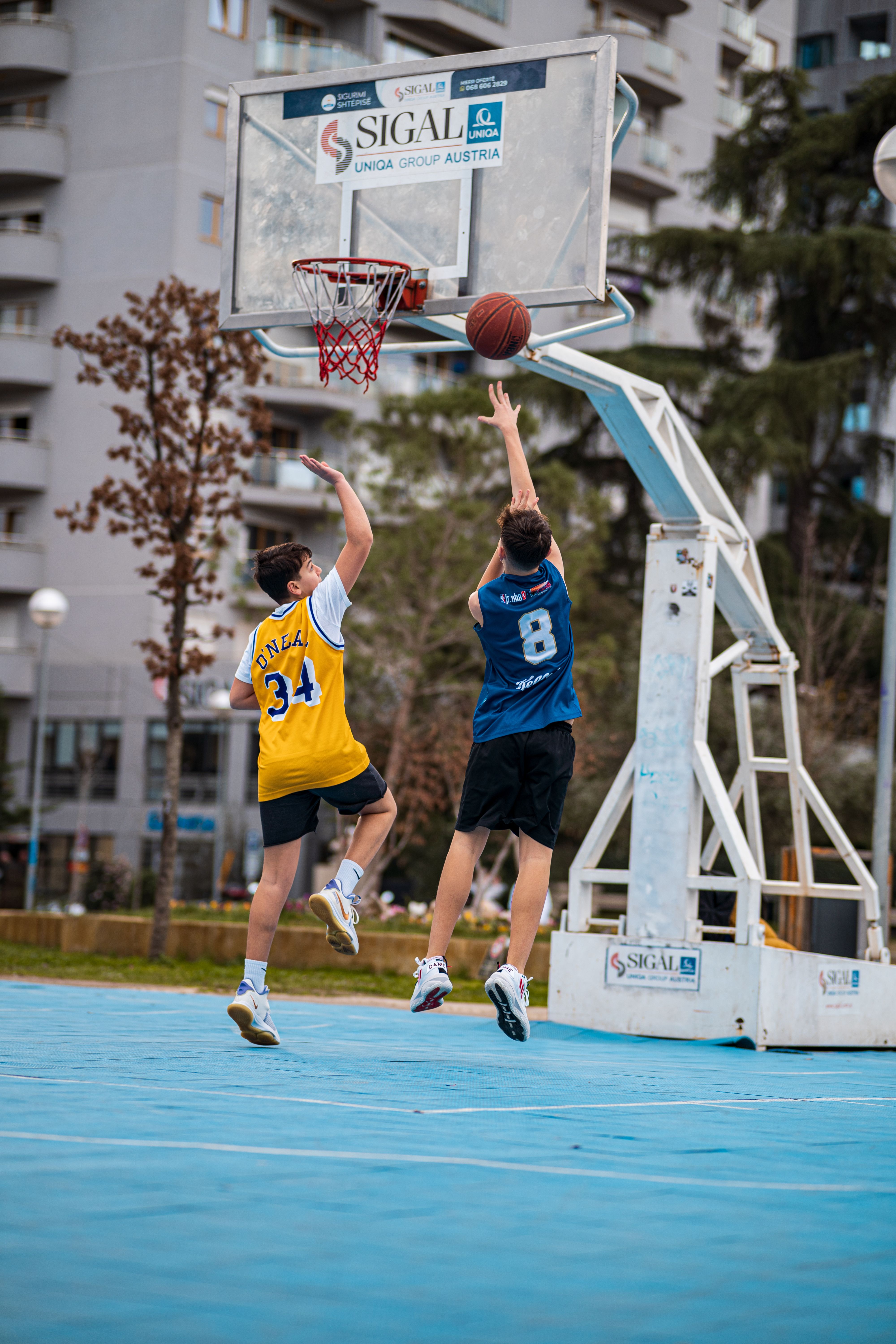 Man Dunking a Ball into the Basket on an Outdoor Basketball Court ...