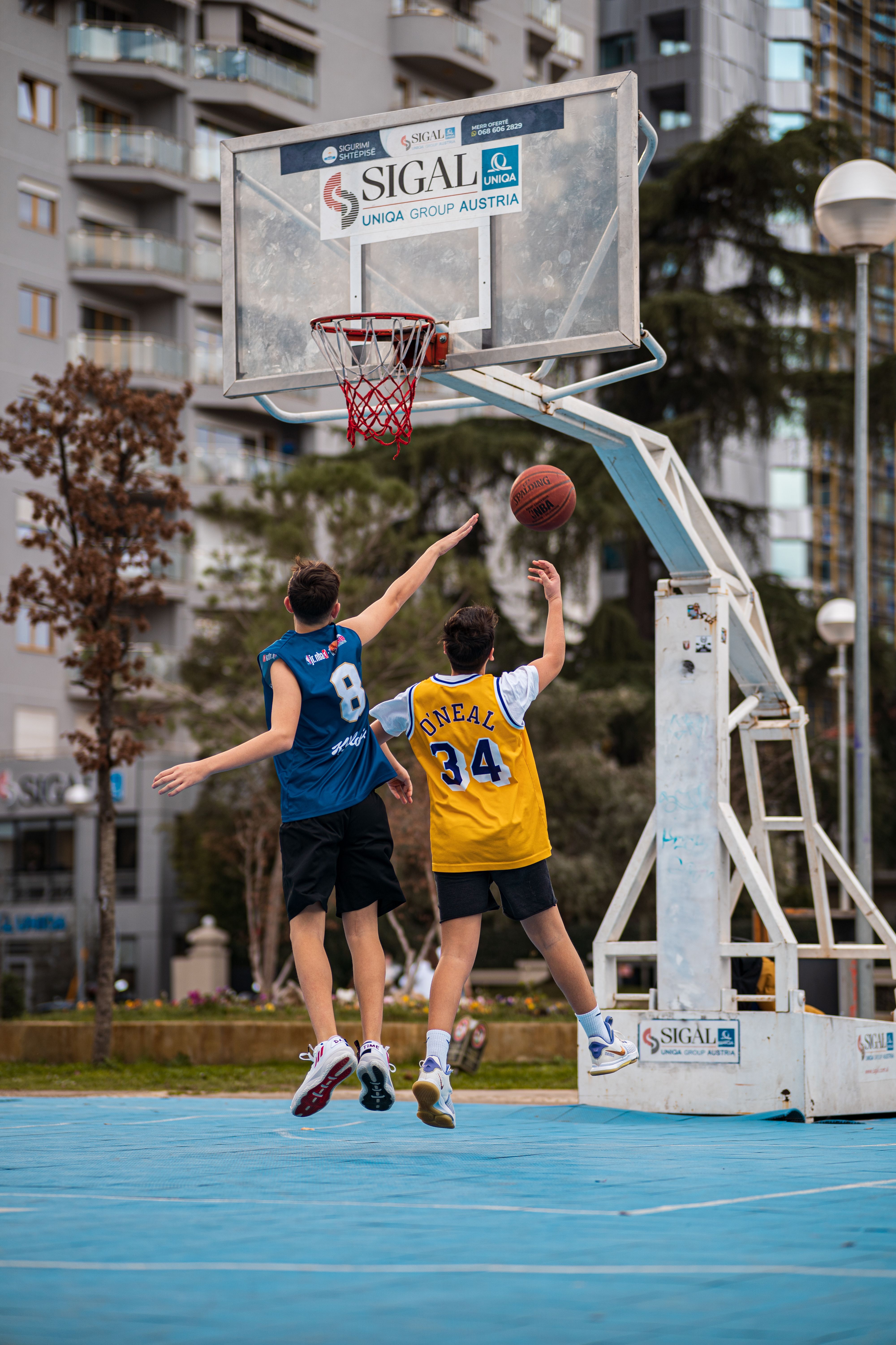 Man Dunking a Ball into the Basket on an Outdoor Basketball Court ...