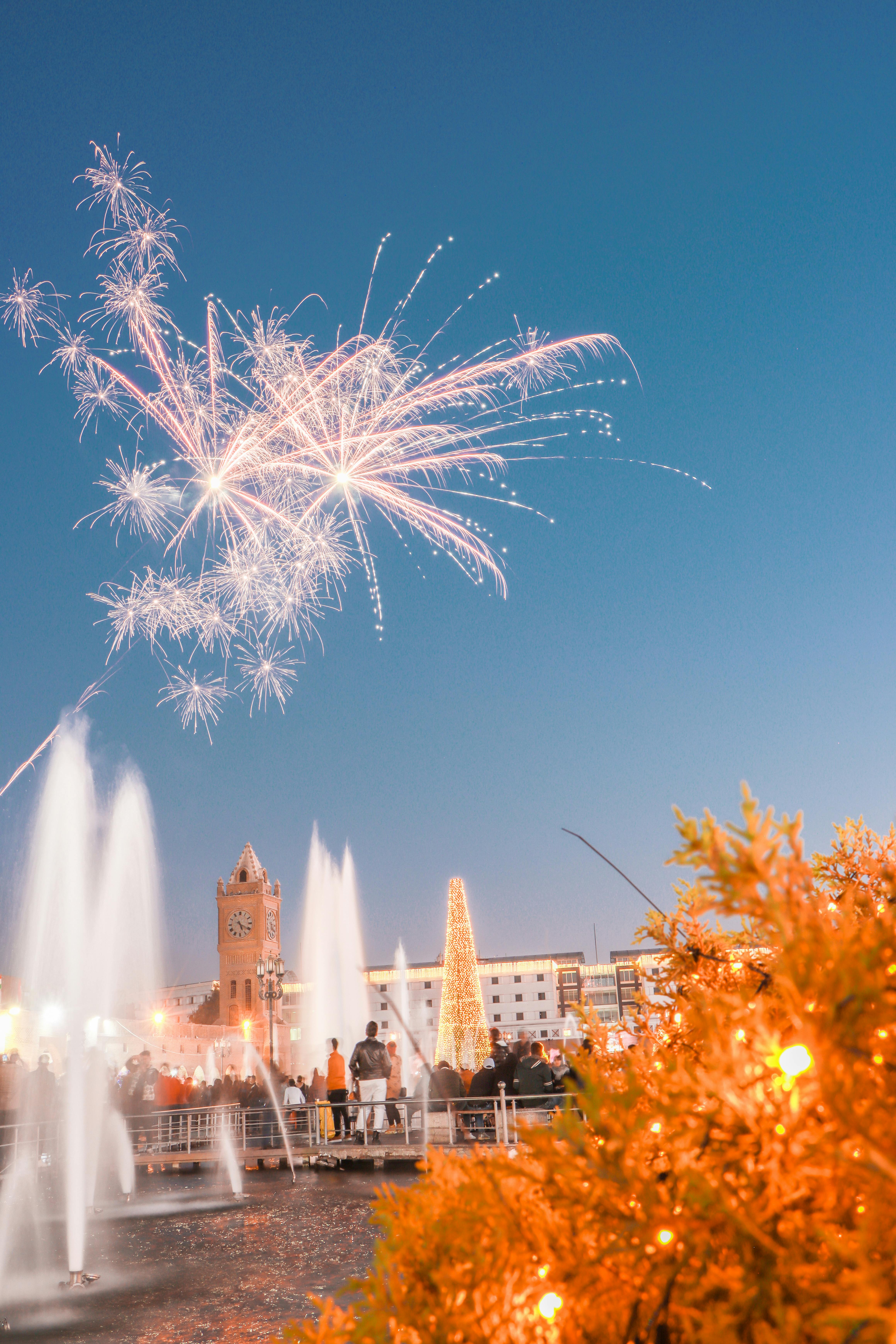 Firework Display over a Town Square · Free Stock Photo