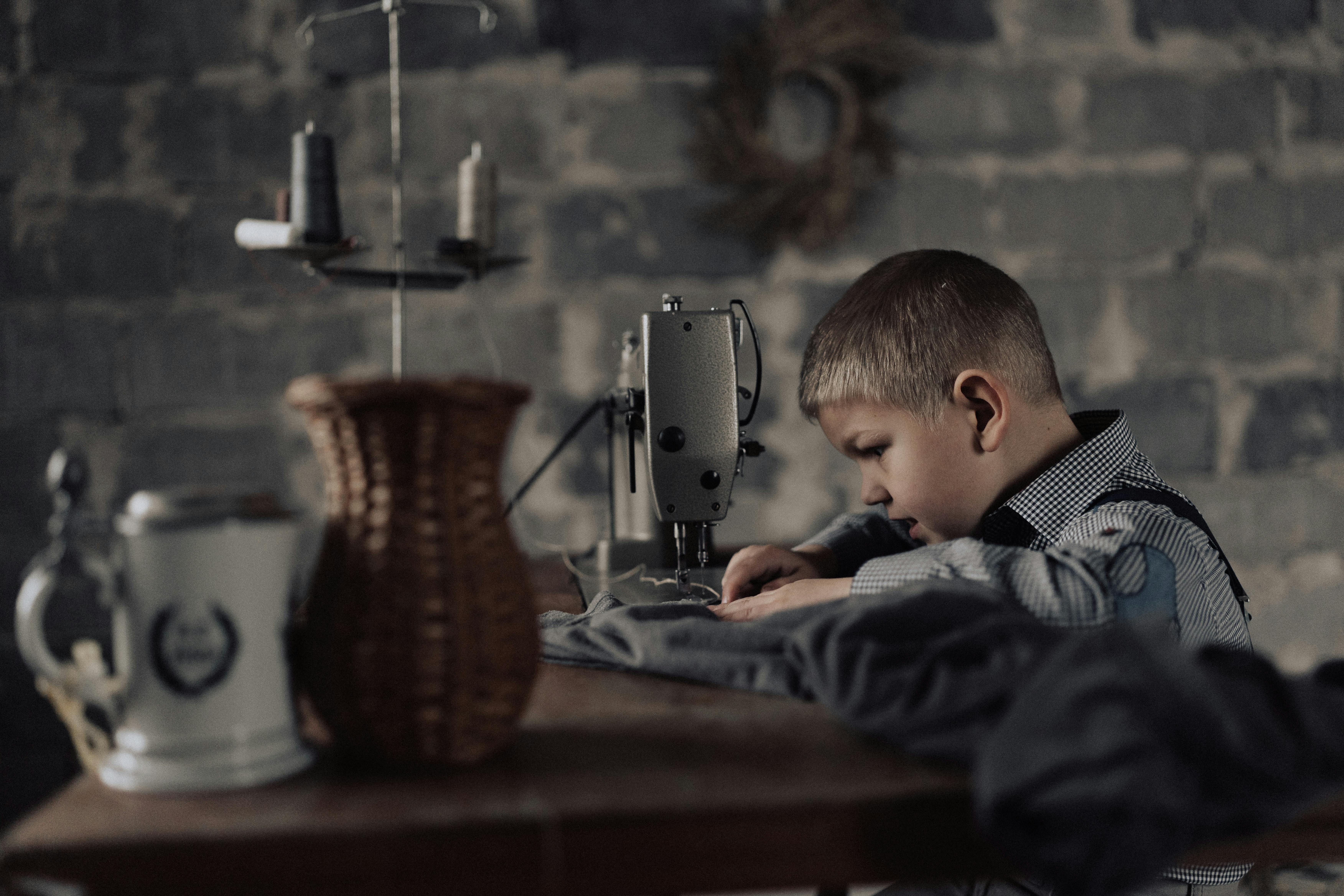 Boy Sitting and Sewing · Free Stock Photo