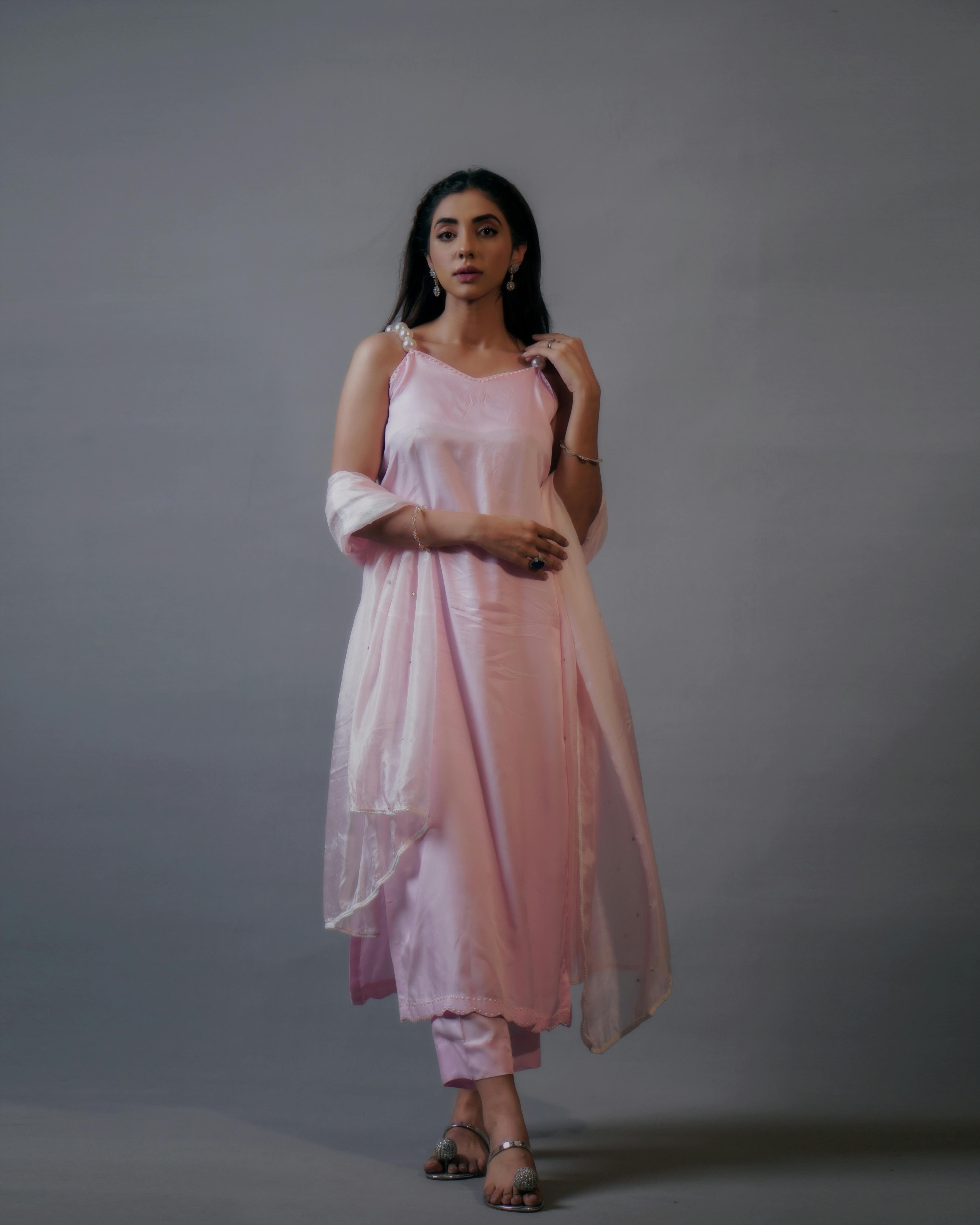 Woman in PInk Dress Standing Sideways · Free Stock Photo