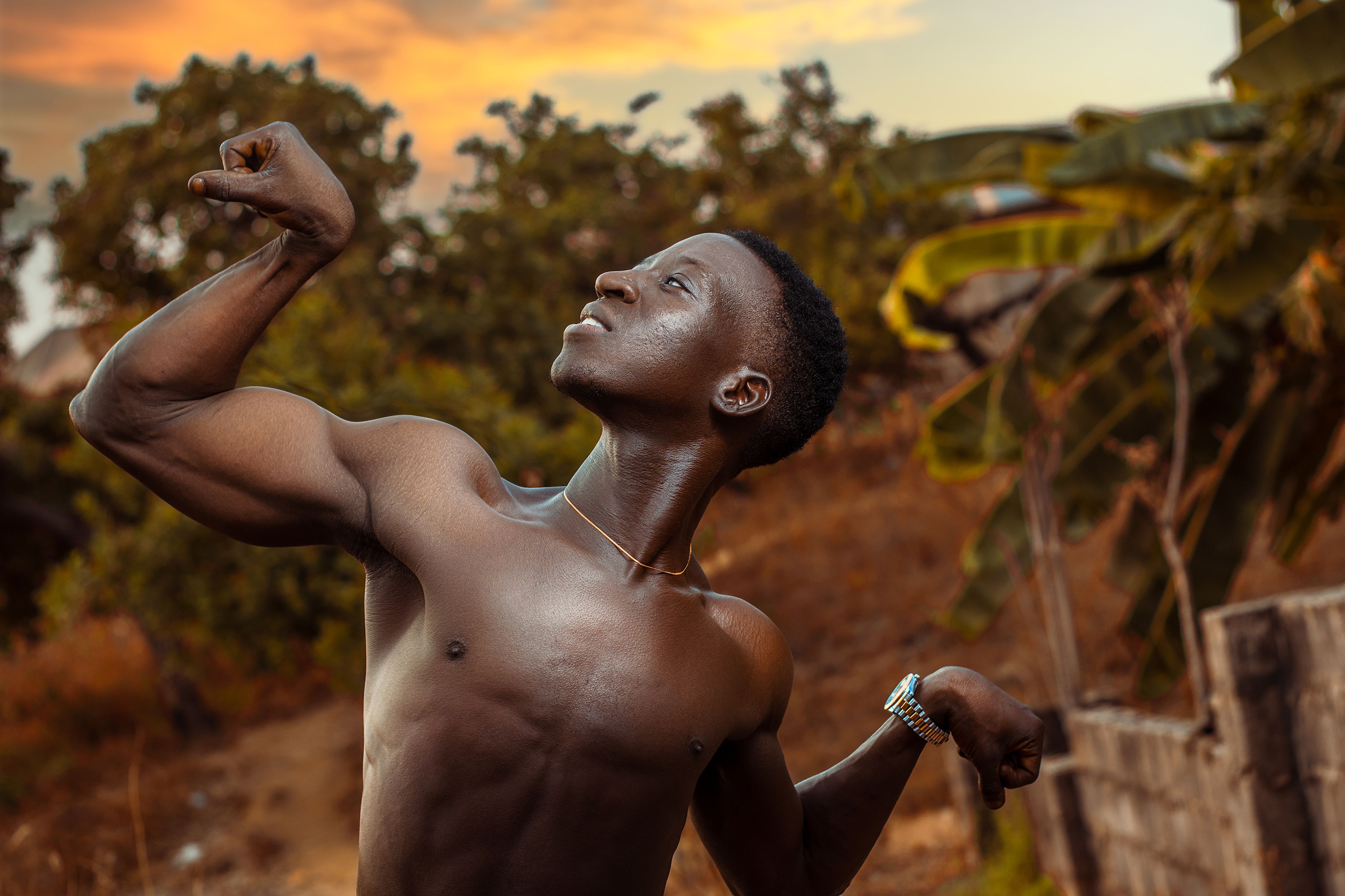 Shirtless Man Flexing His Biceps · Free Stock Photo