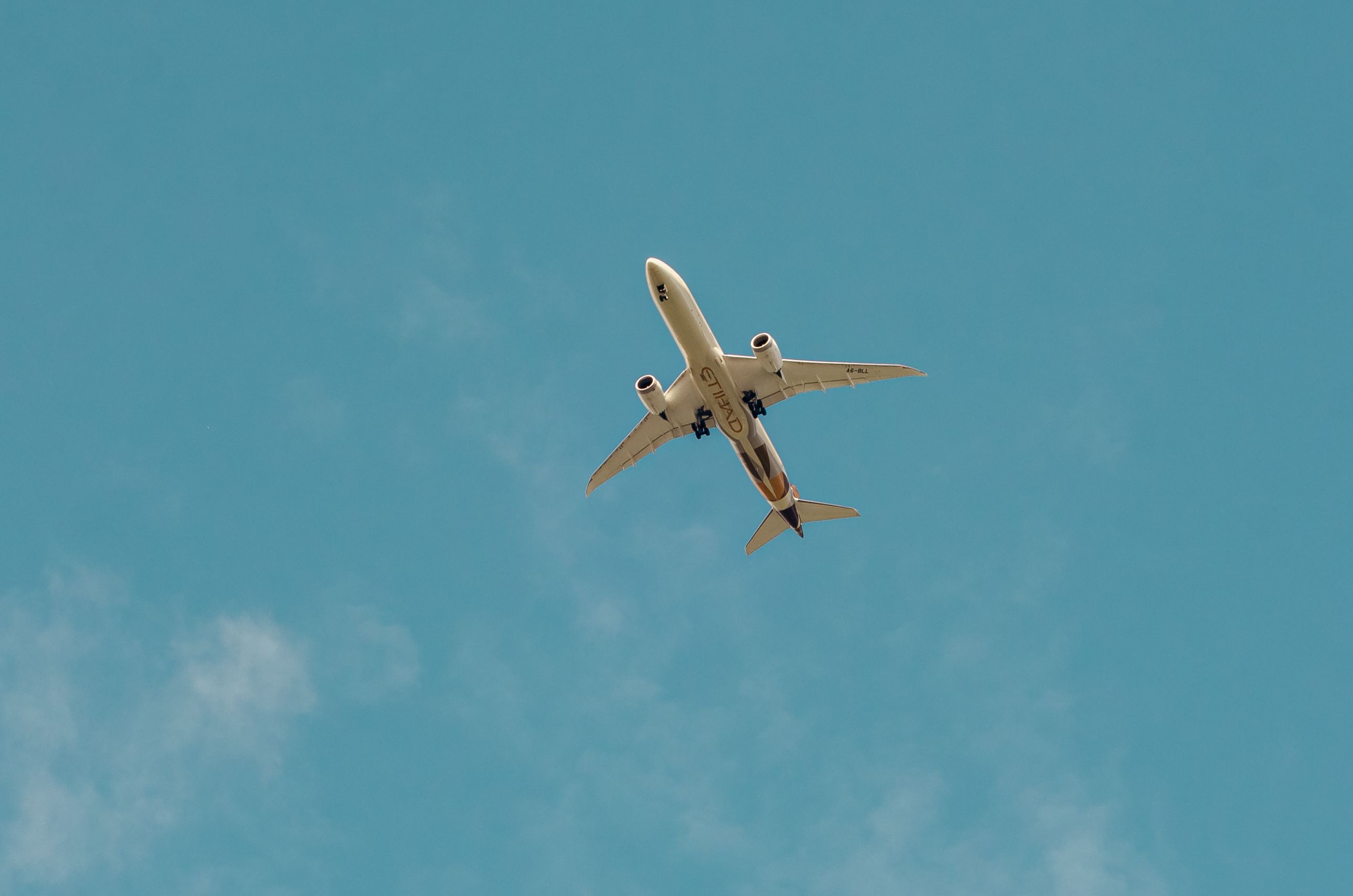 Low Angle Shot of an Airplane Under Blue Sky · Free Stock Photo