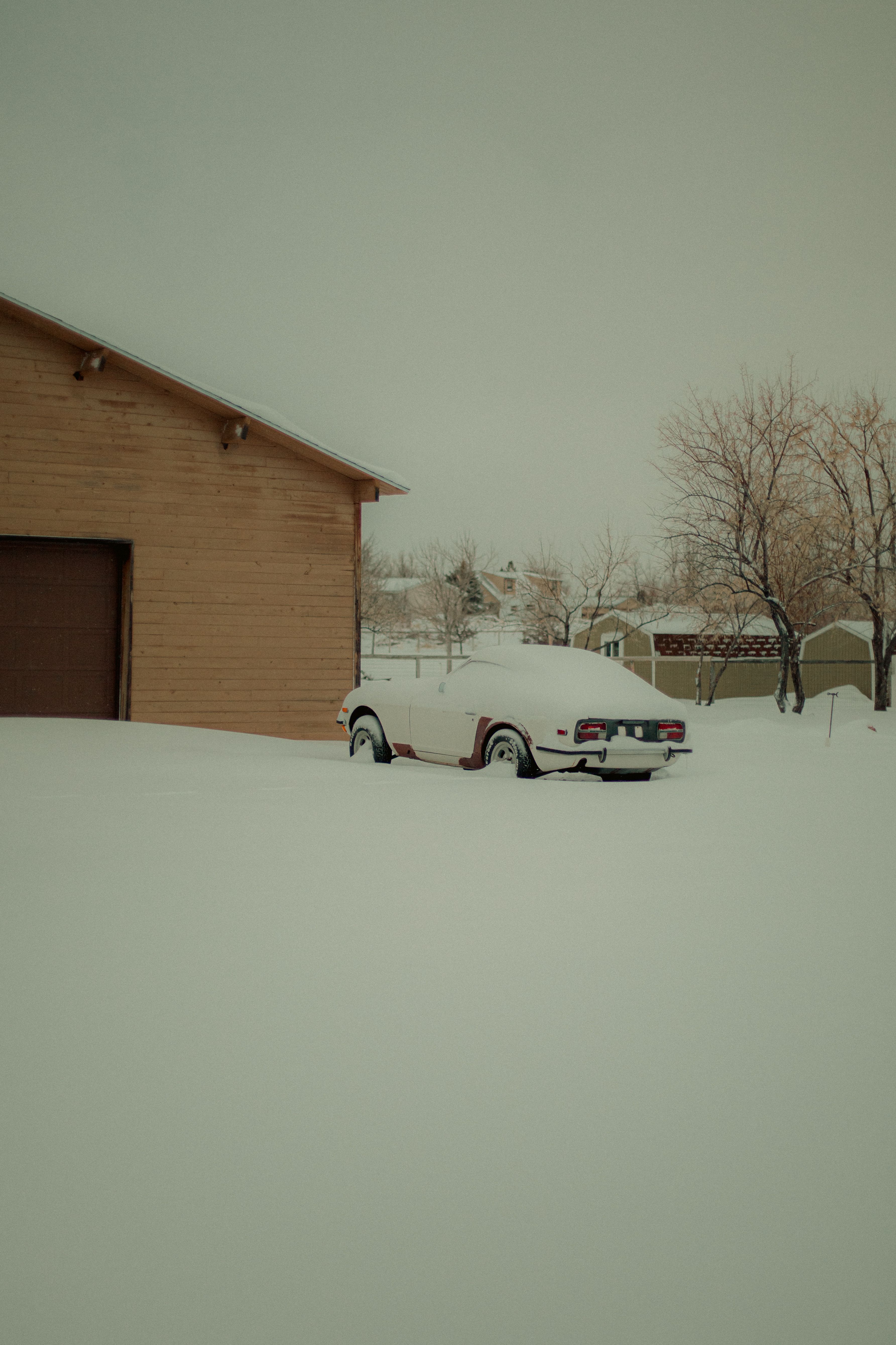Snowed Car in front of a Garage · Free Stock Photo