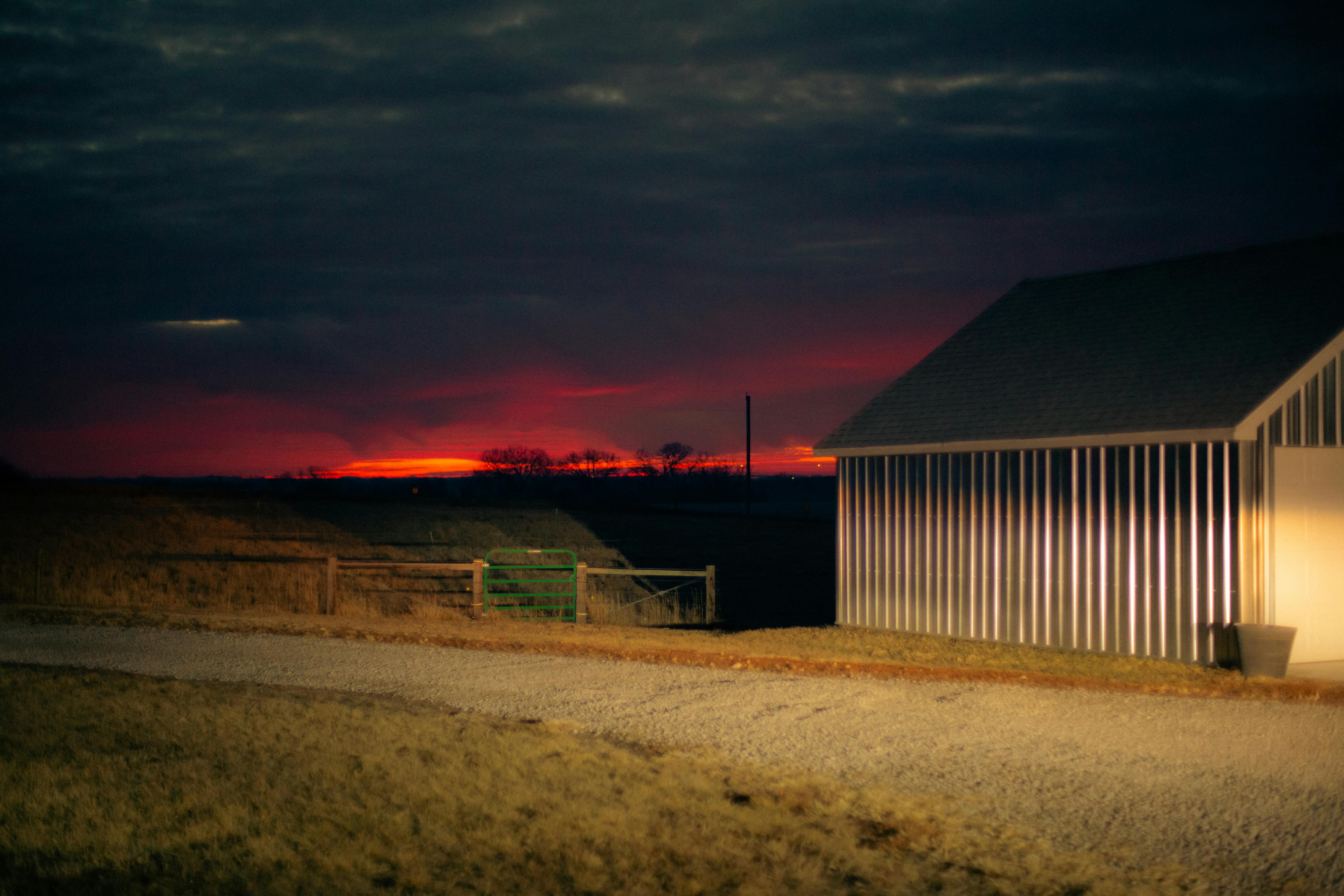 Dramatic Sunset over a Farmhouse · Free Stock Photo