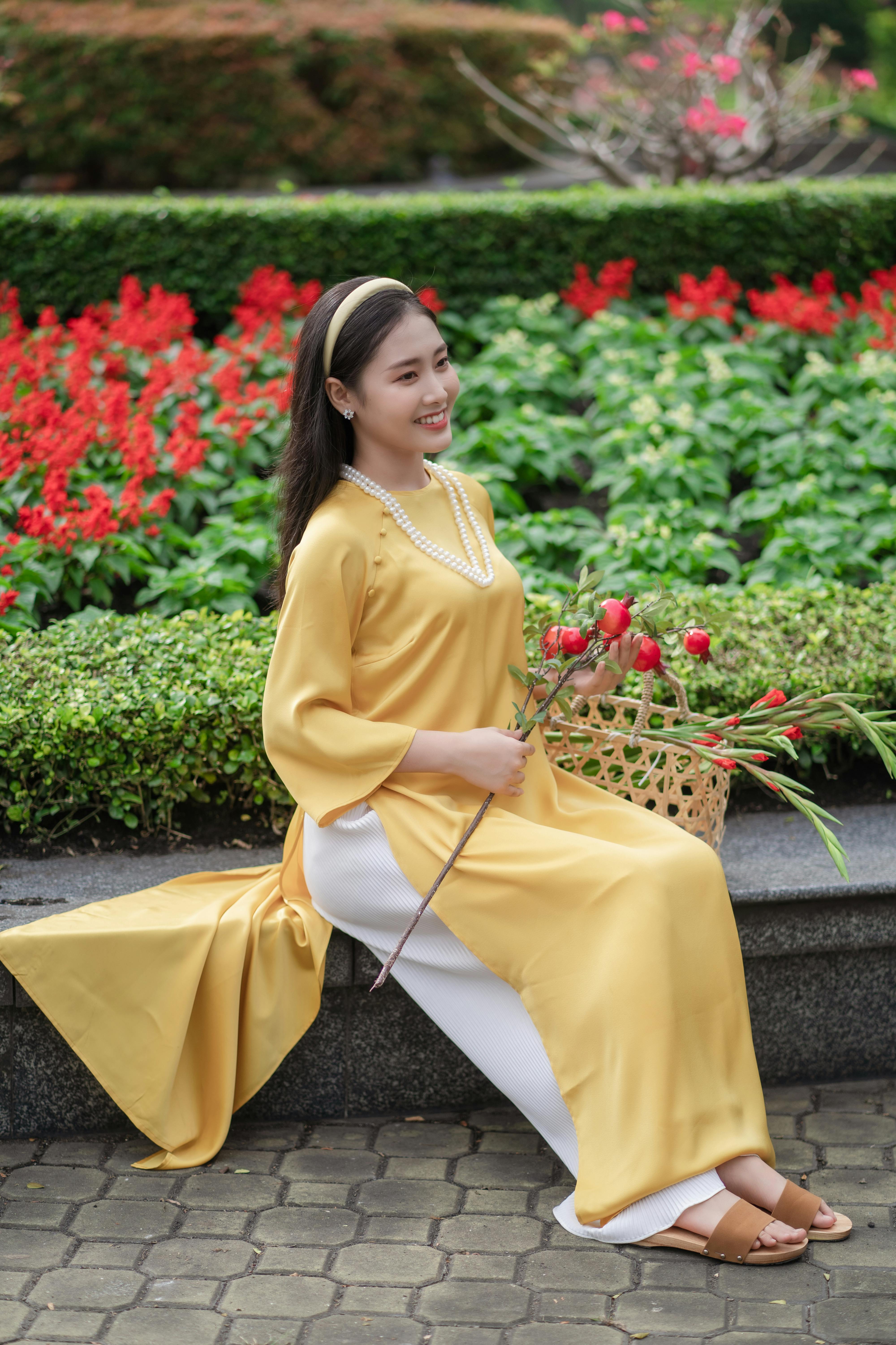 Woman Wearing a Yellow Traditional Dress Sitting on a Plant Box · Free ...