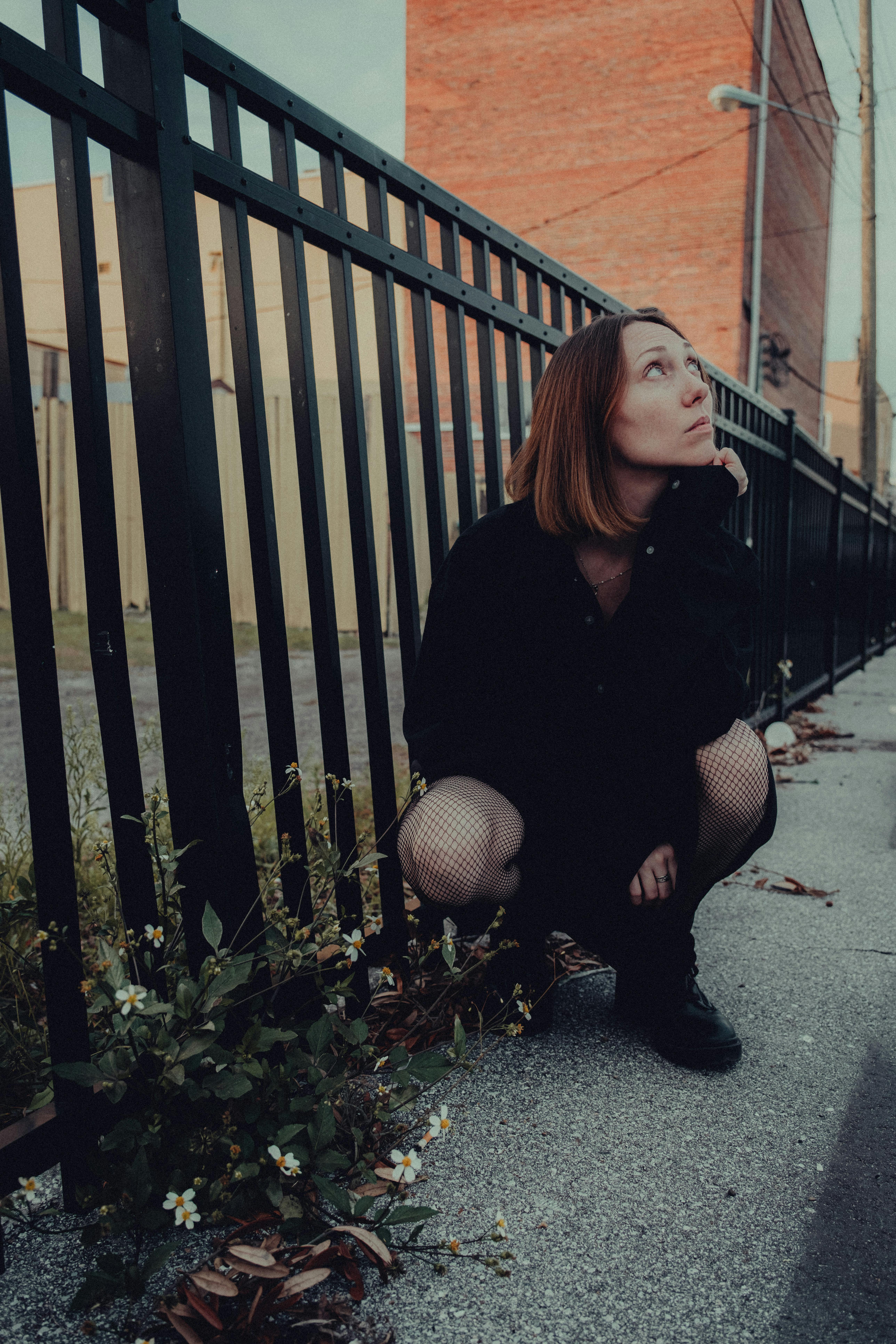 Woman Crouching on Sidewalk · Free Stock Photo