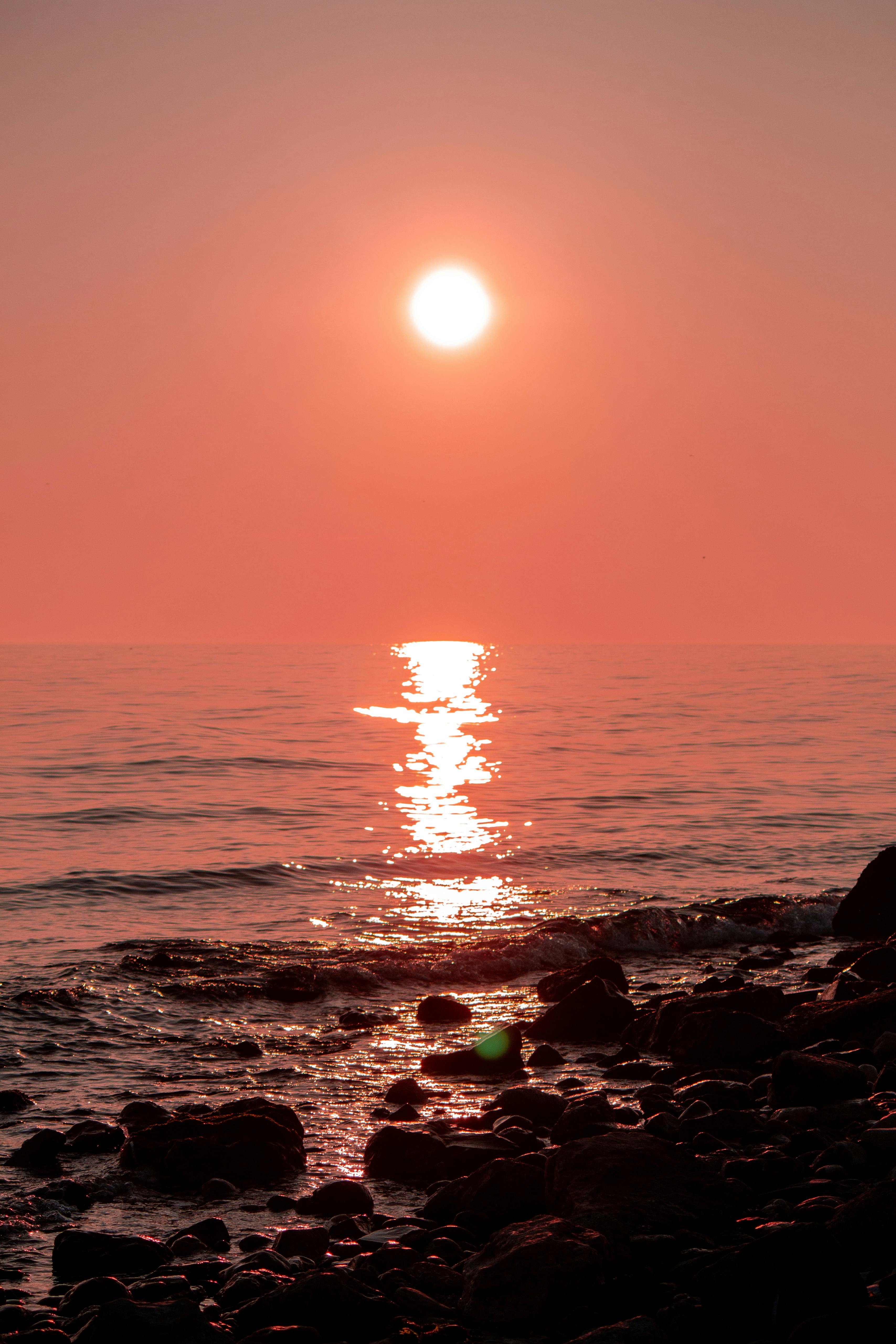 Sun on Clear Sky over Sea Shore at Sunset · Free Stock Photo