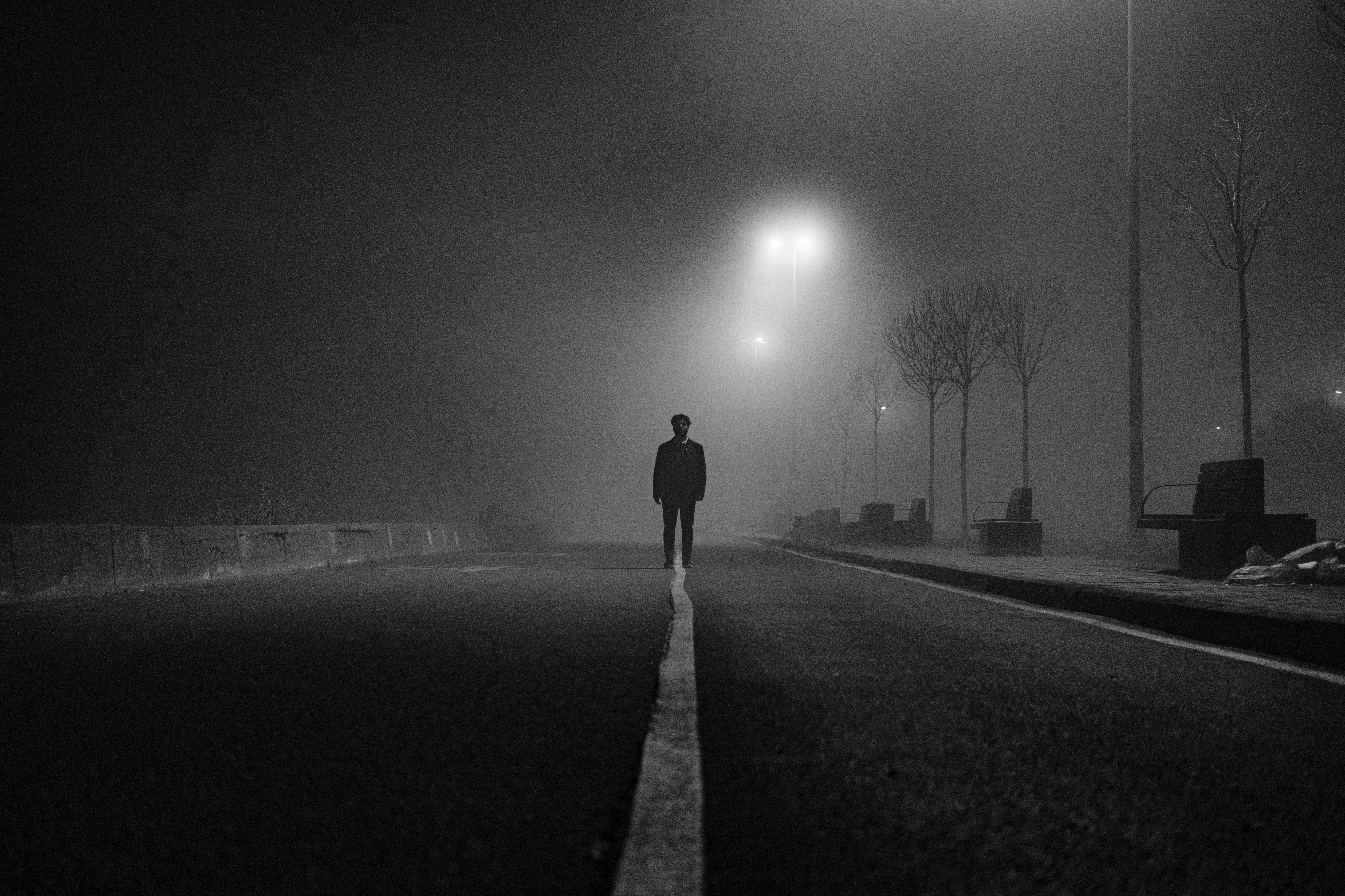 Person Standing in Darkness in Alley in Black and White · Free Stock Photo