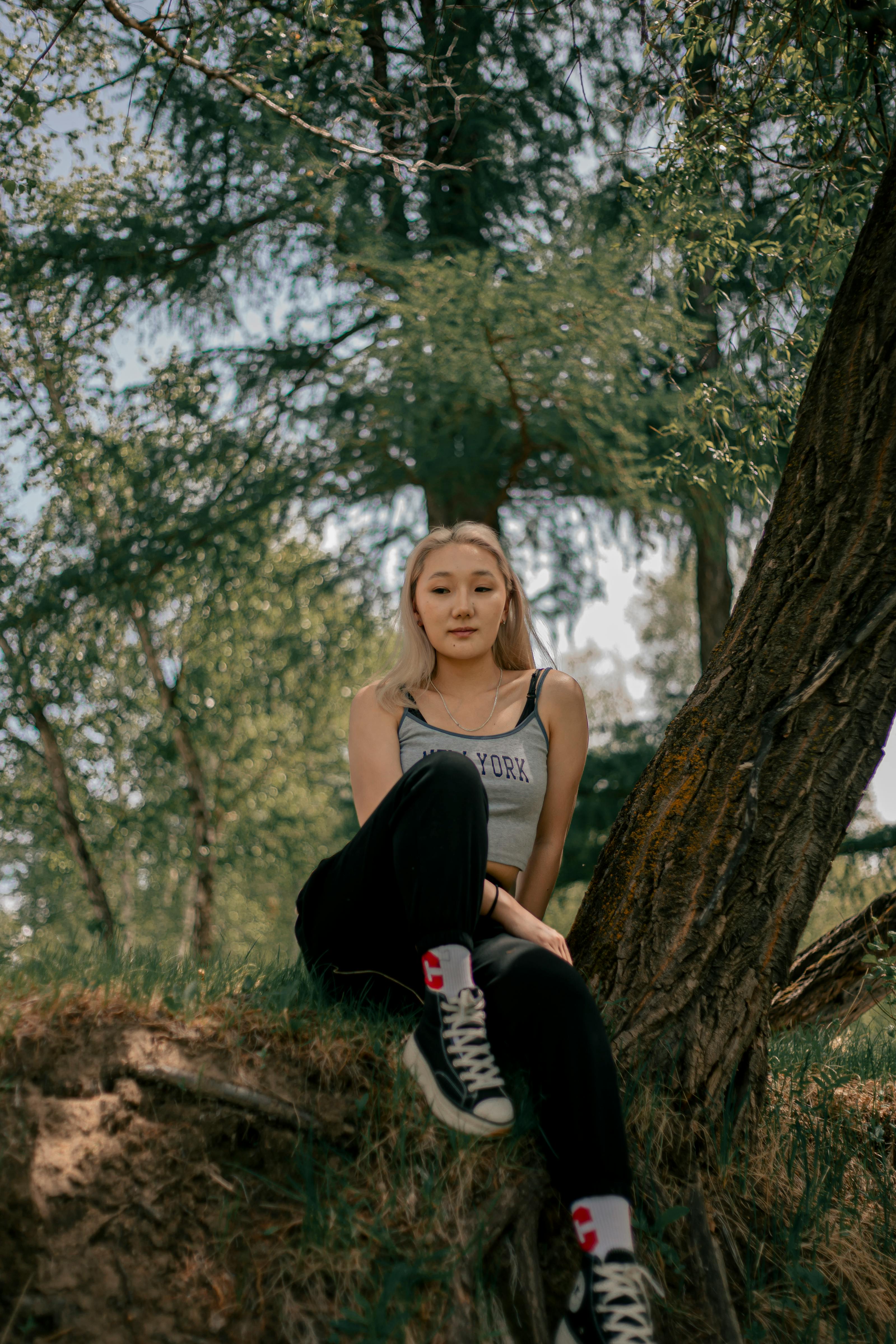 Girl Sitting on Tree in Forest · Free Stock Photo