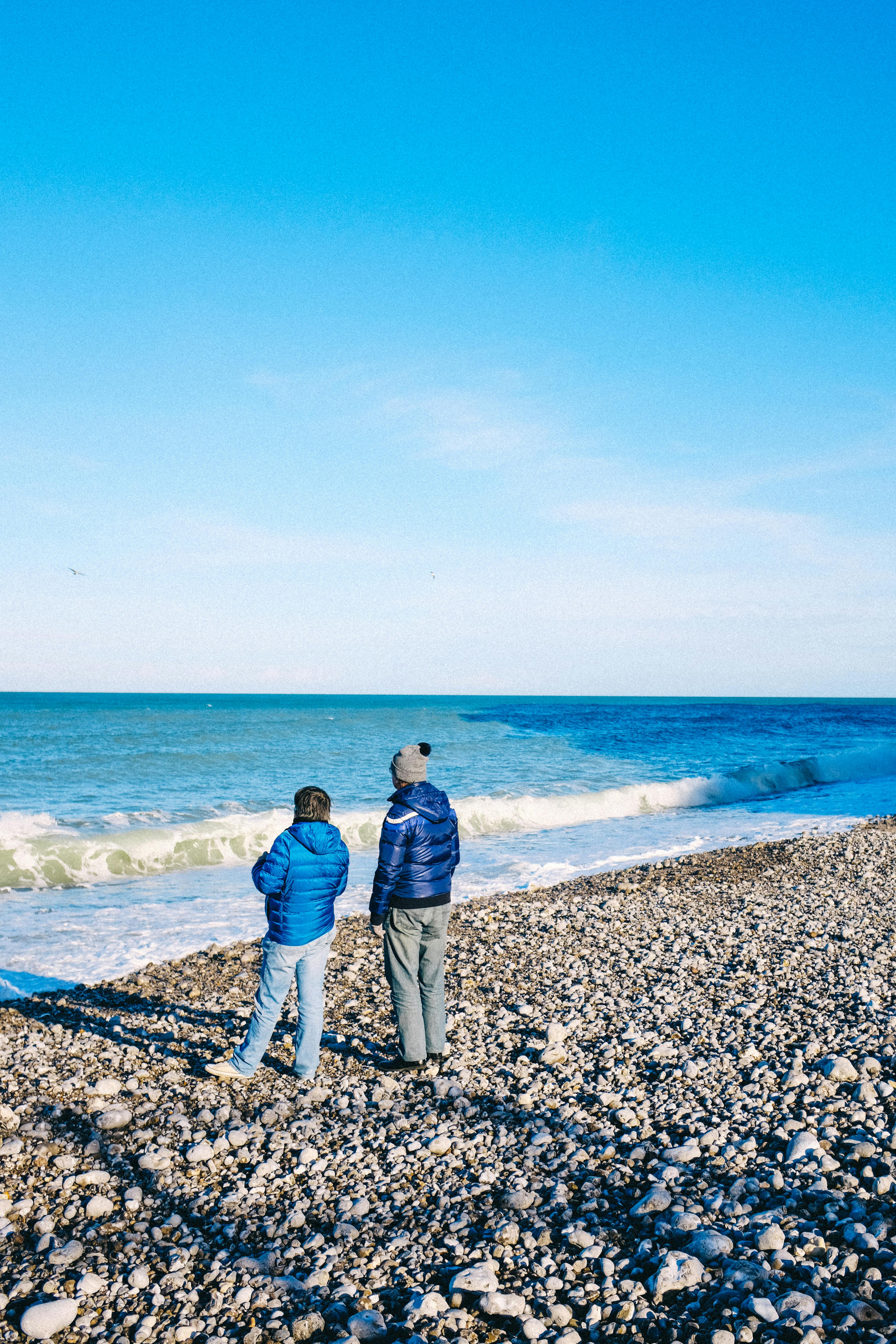 Photo of Two Person Standing on the Beach · Free Stock Photo