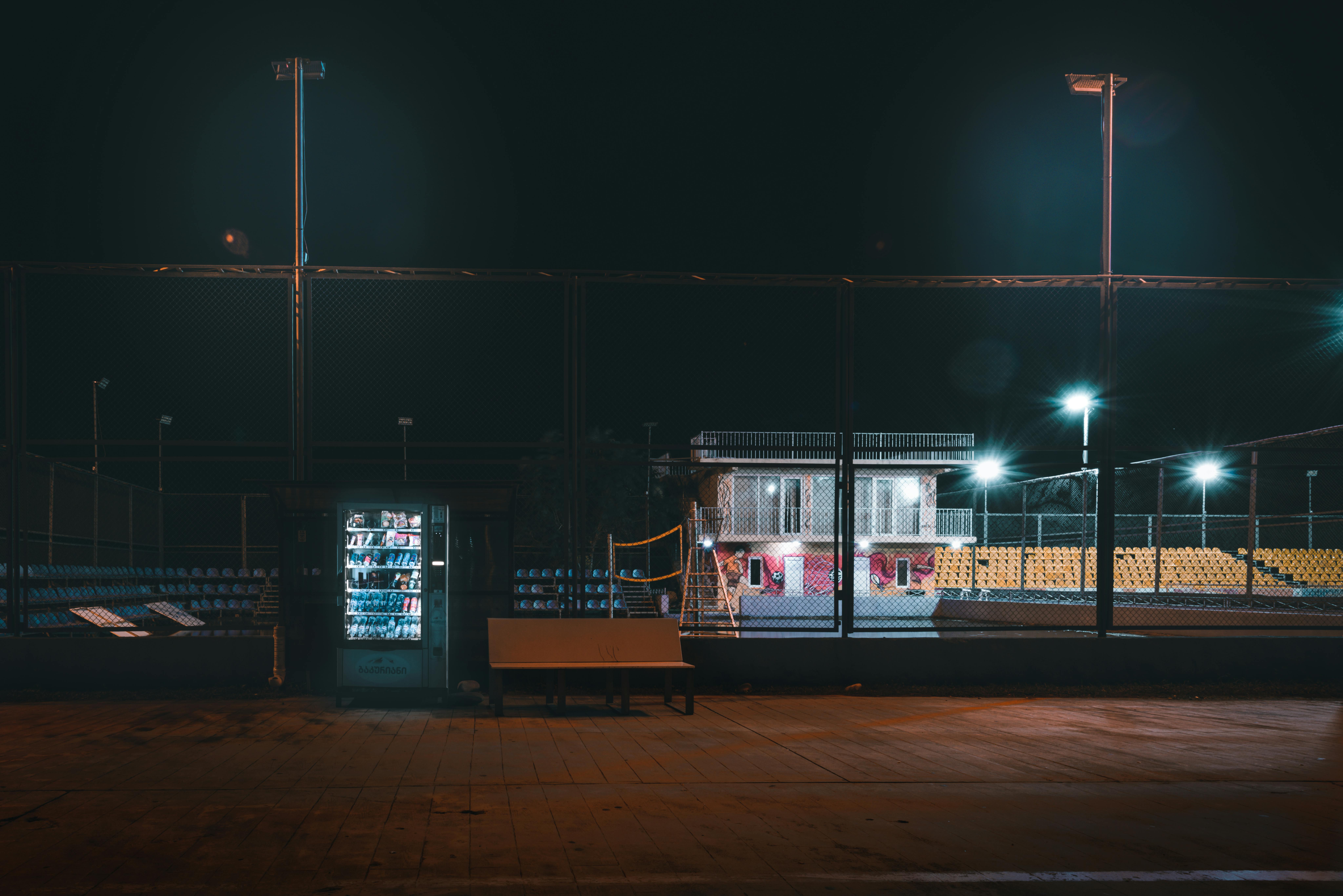 Vending Machine Beside a Bench · Free Stock Photo
