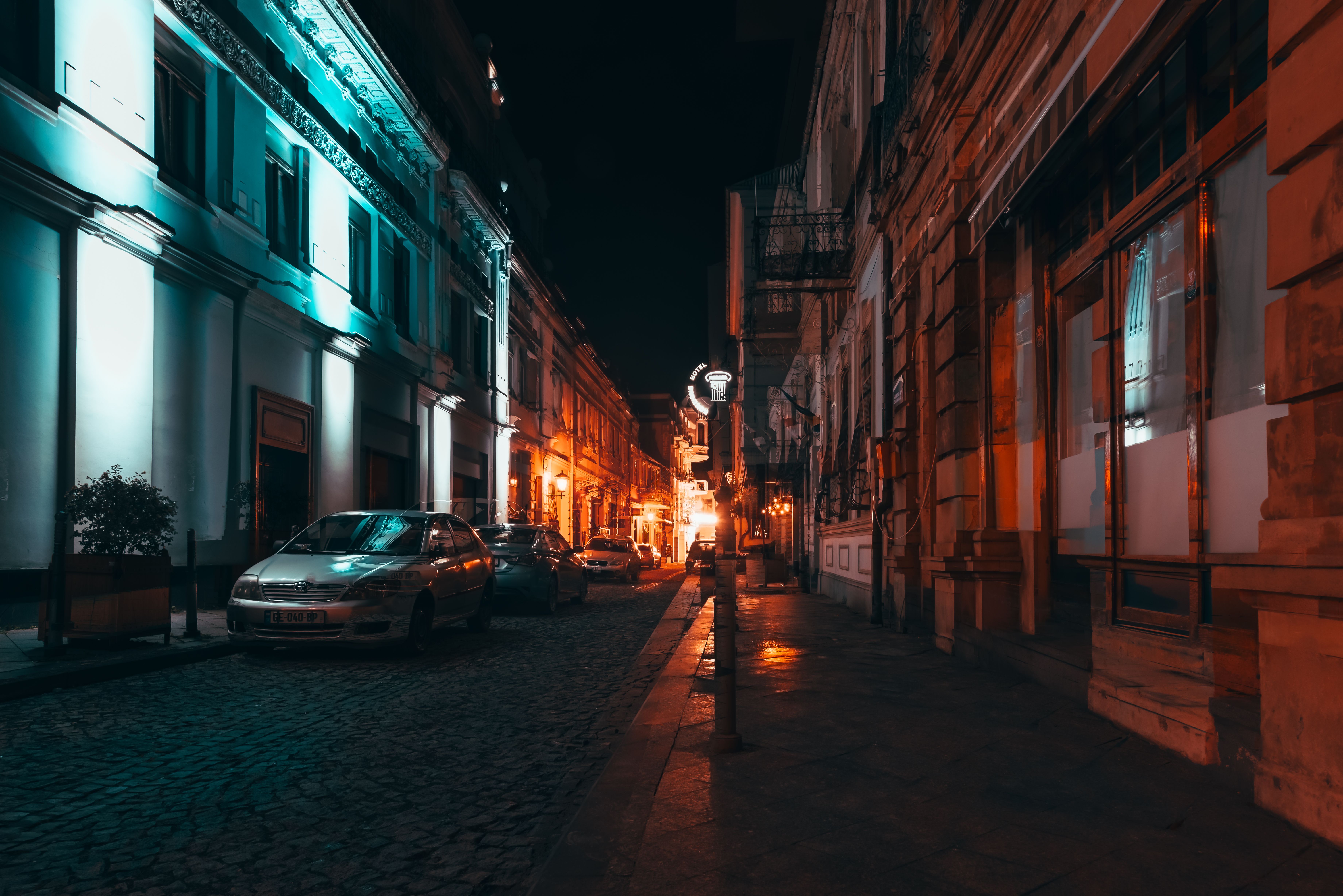 Cars Parked on the Street at Night Between Buildings · Free Stock Photo