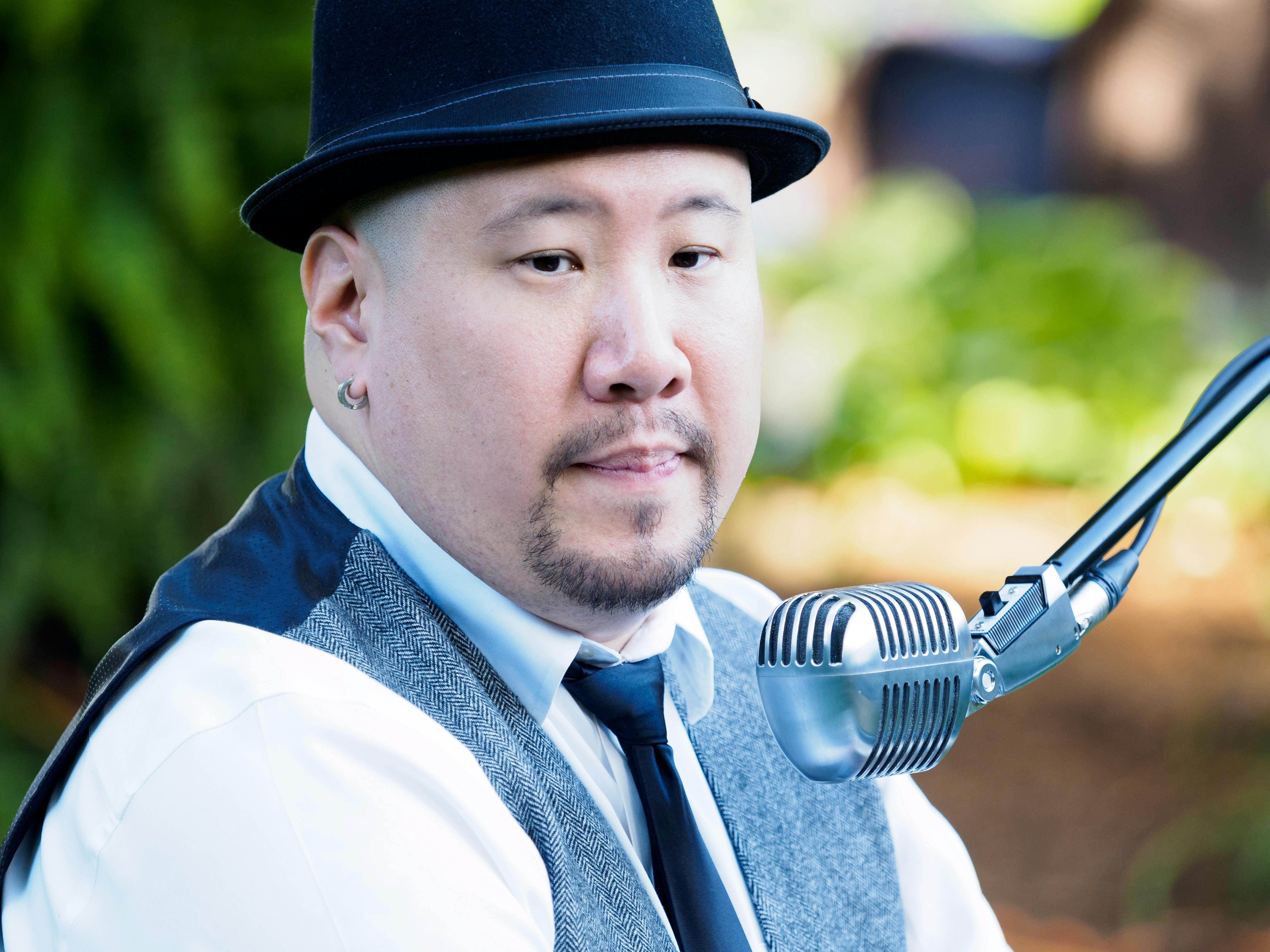 Portrait of Singer with Microphone · Free Stock Photo