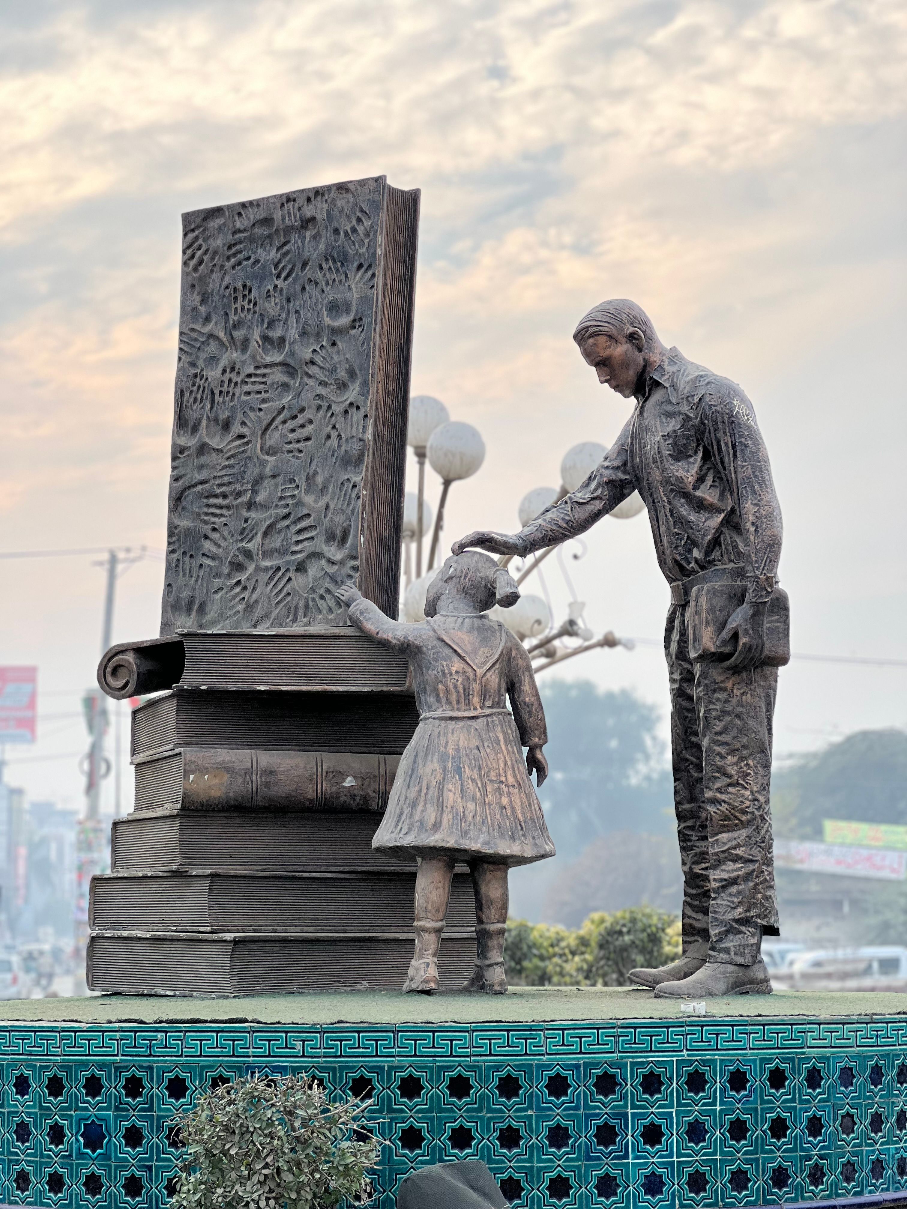 Statue of a Little Girl and a Man next to Large Books · Free Stock Photo