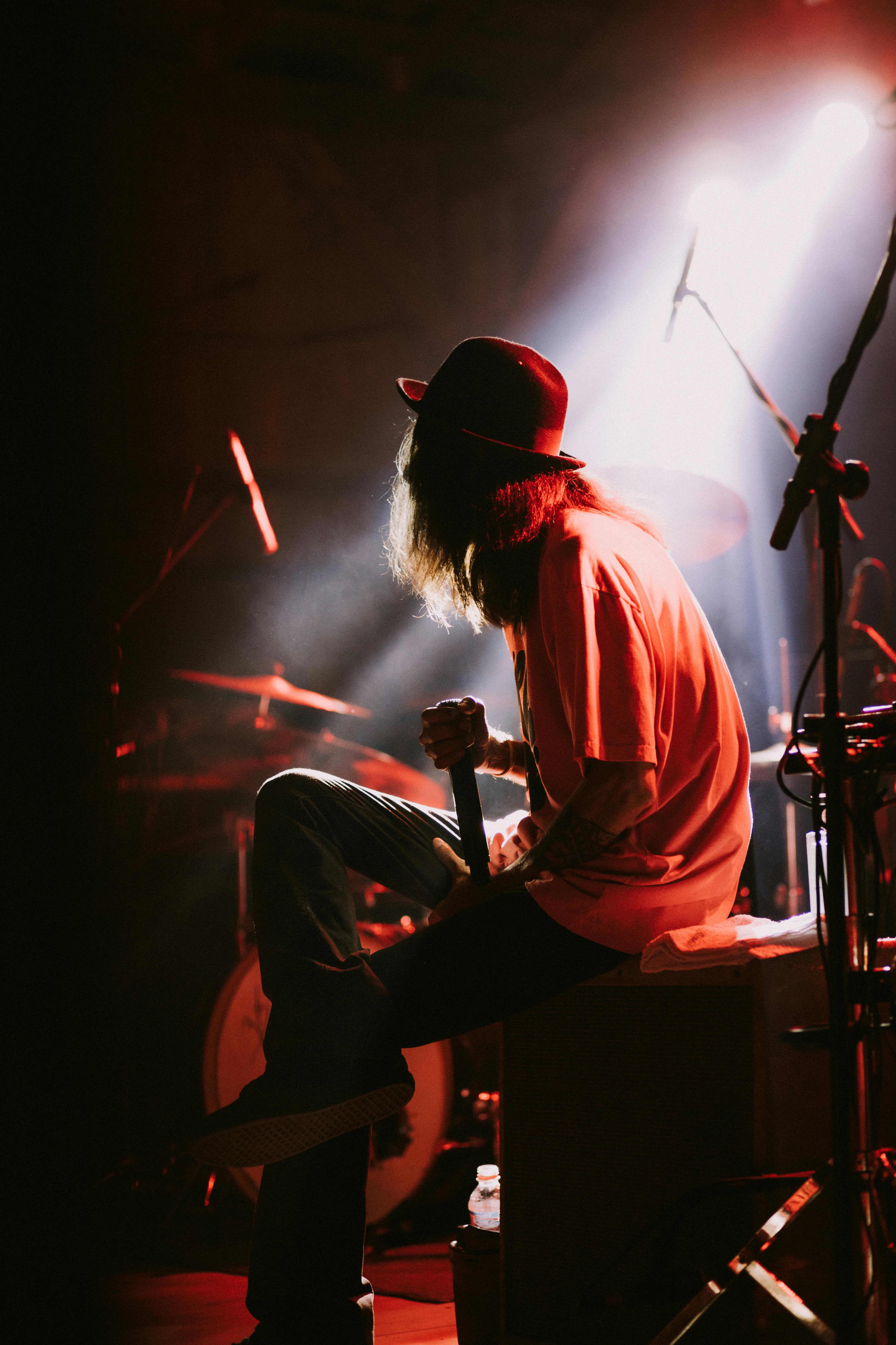 Man Singing on Stage With Stage Lights Near Crowd · Free Stock Photo