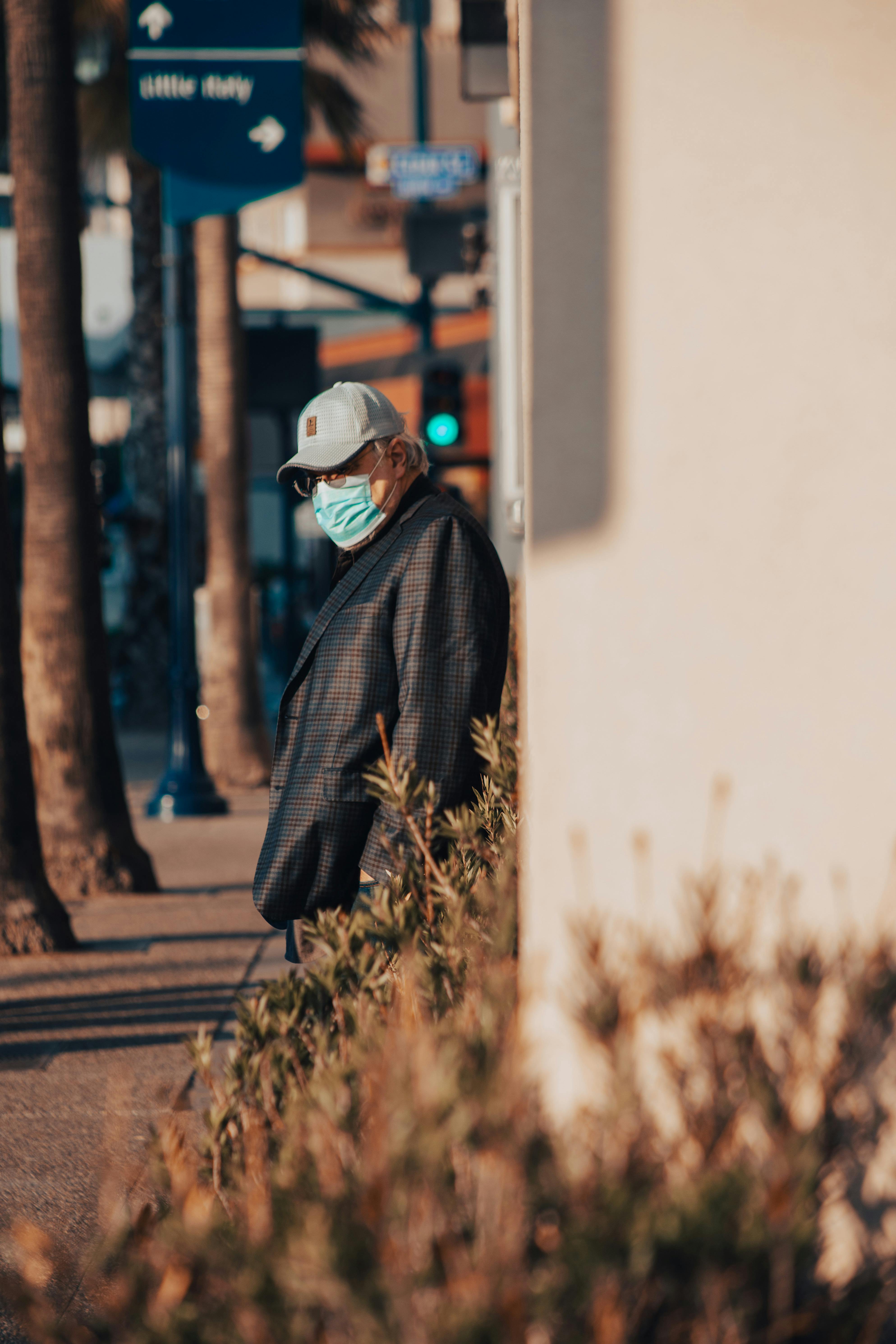 Man in Mask Standing near Wall · Free Stock Photo