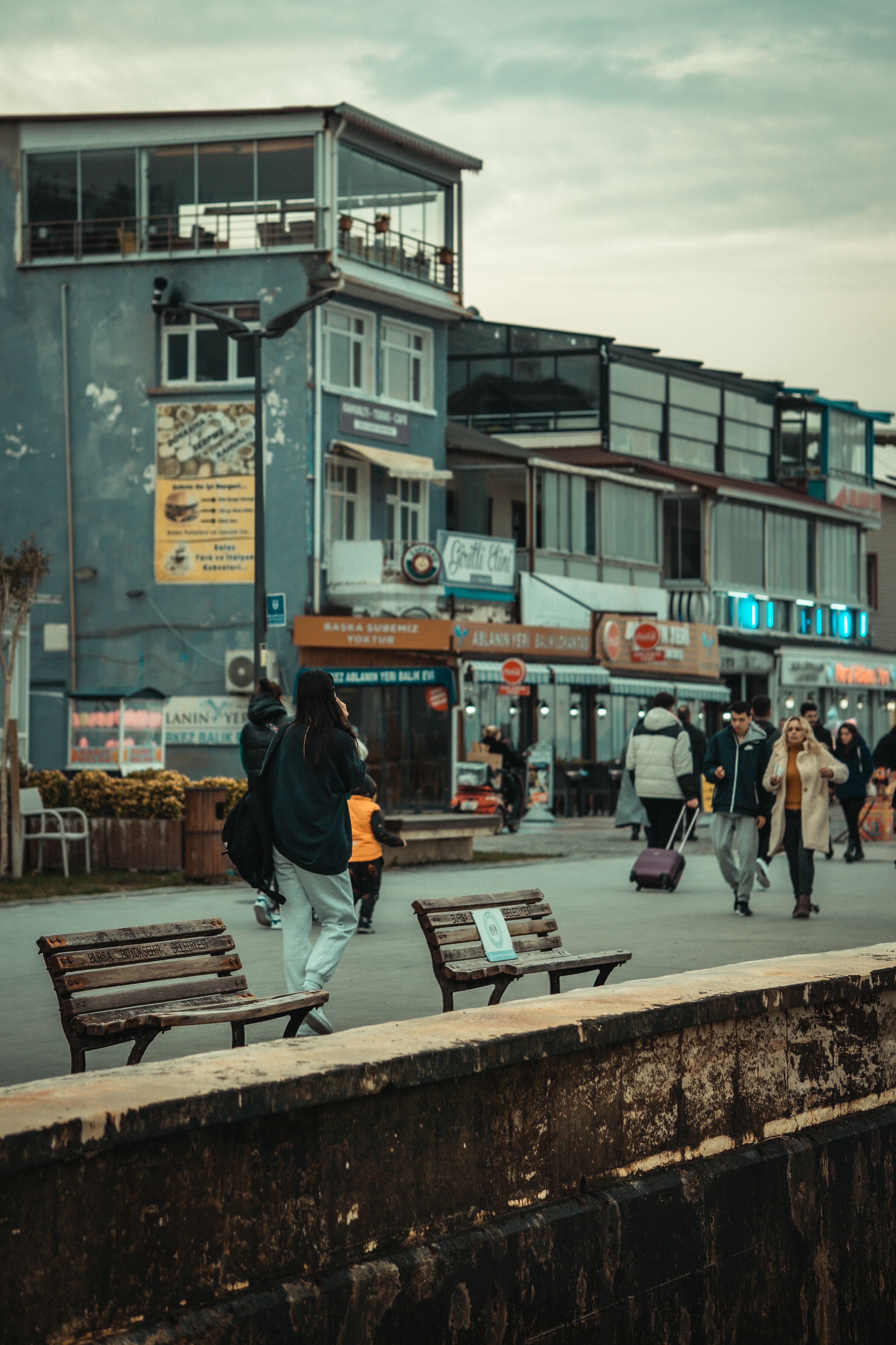 People Walking on a Pavement by the River in City · Free Stock Photo