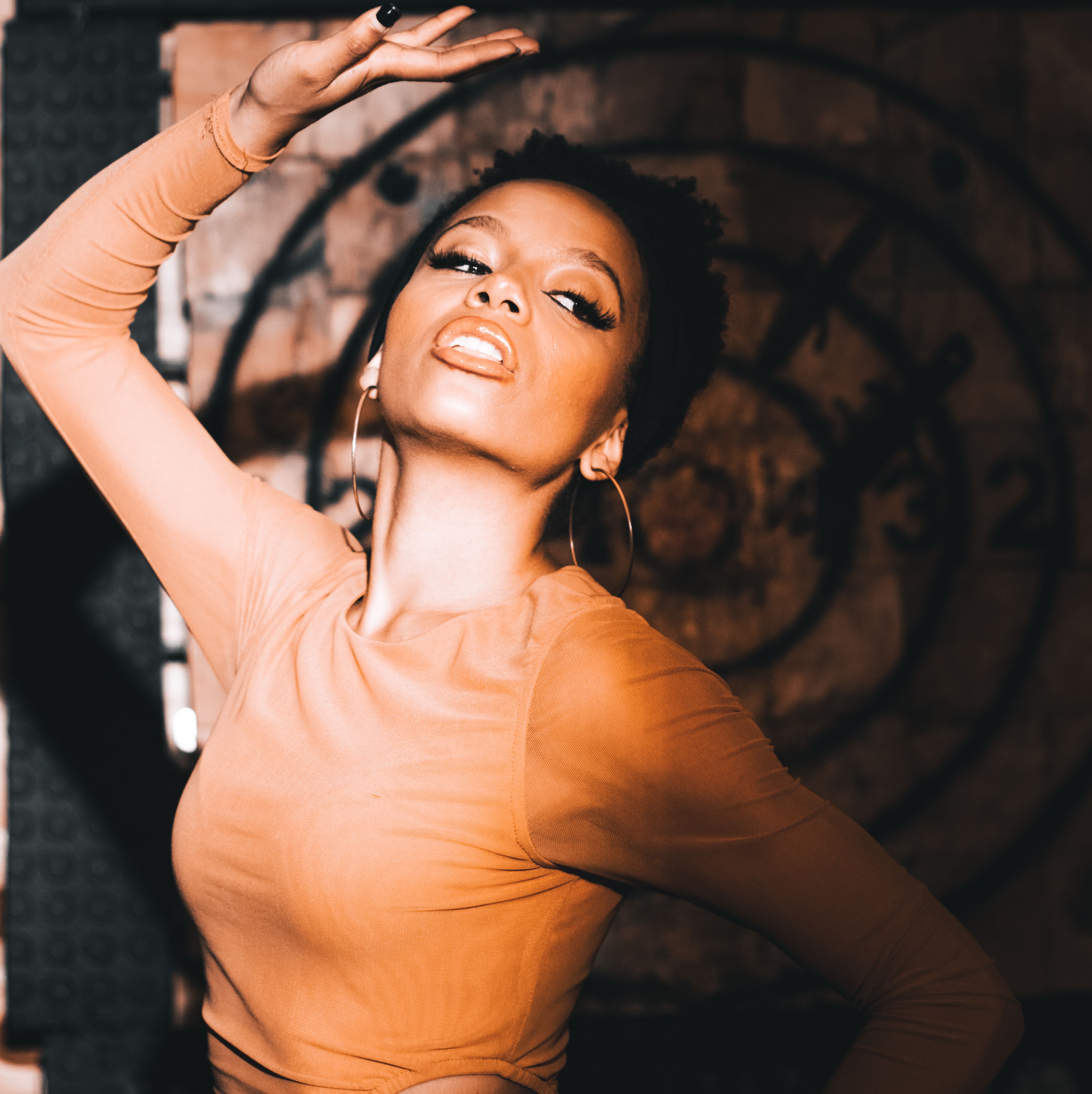 Woman with Loop Earrings Posing · Free Stock Photo