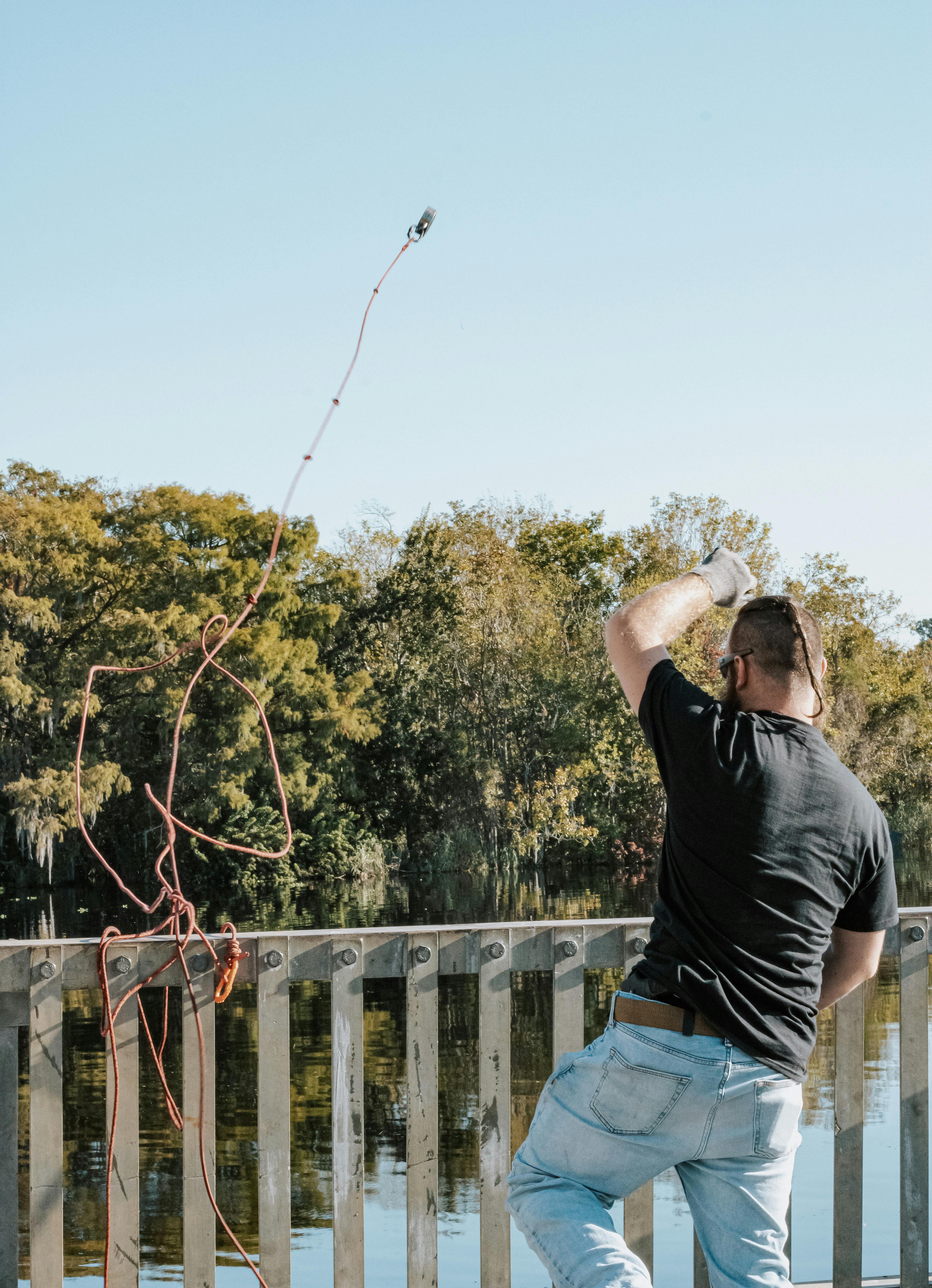 Man Throwing a Rope in the Lake · Free Stock Photo