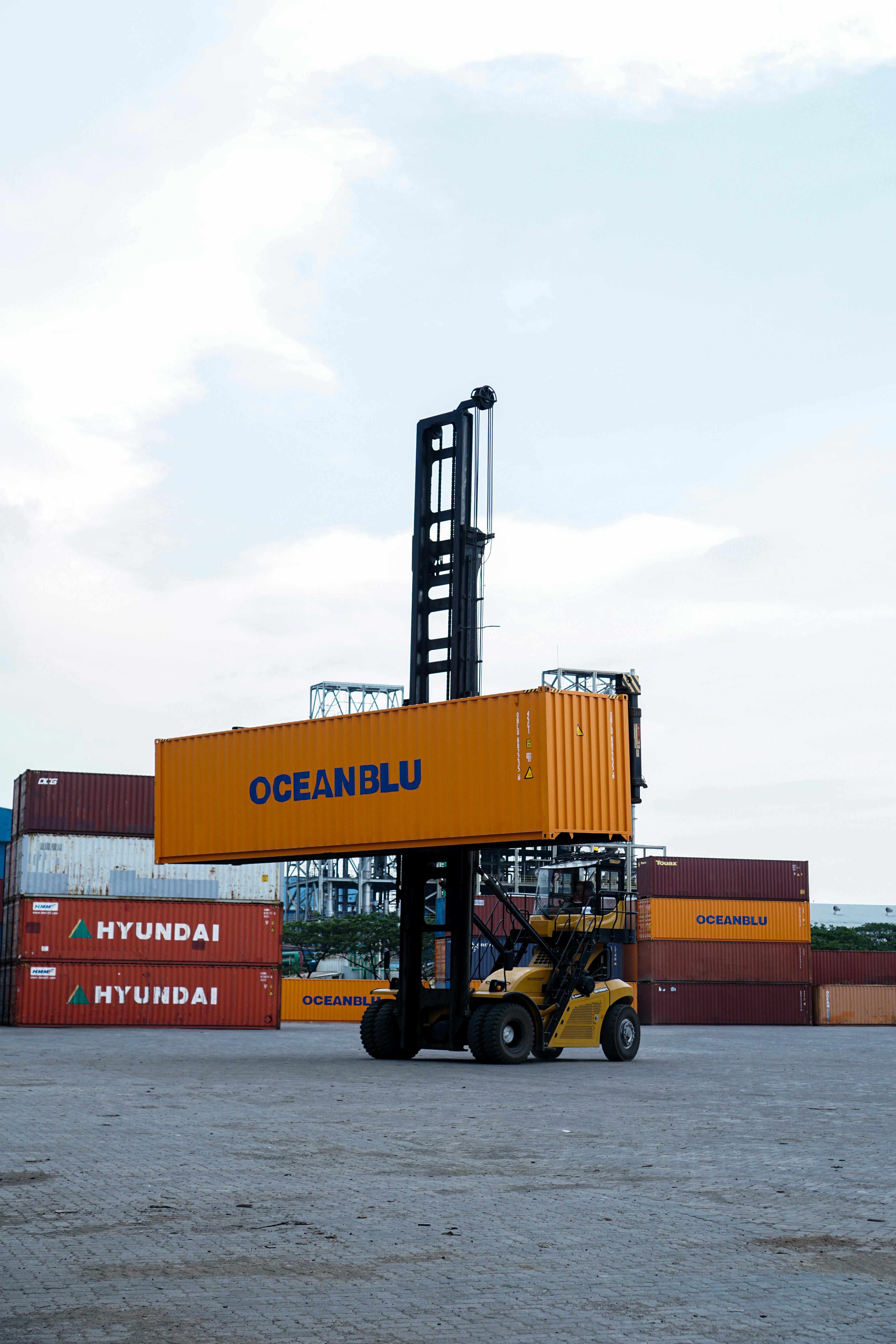 Forklift among Containers · Free Stock Photo