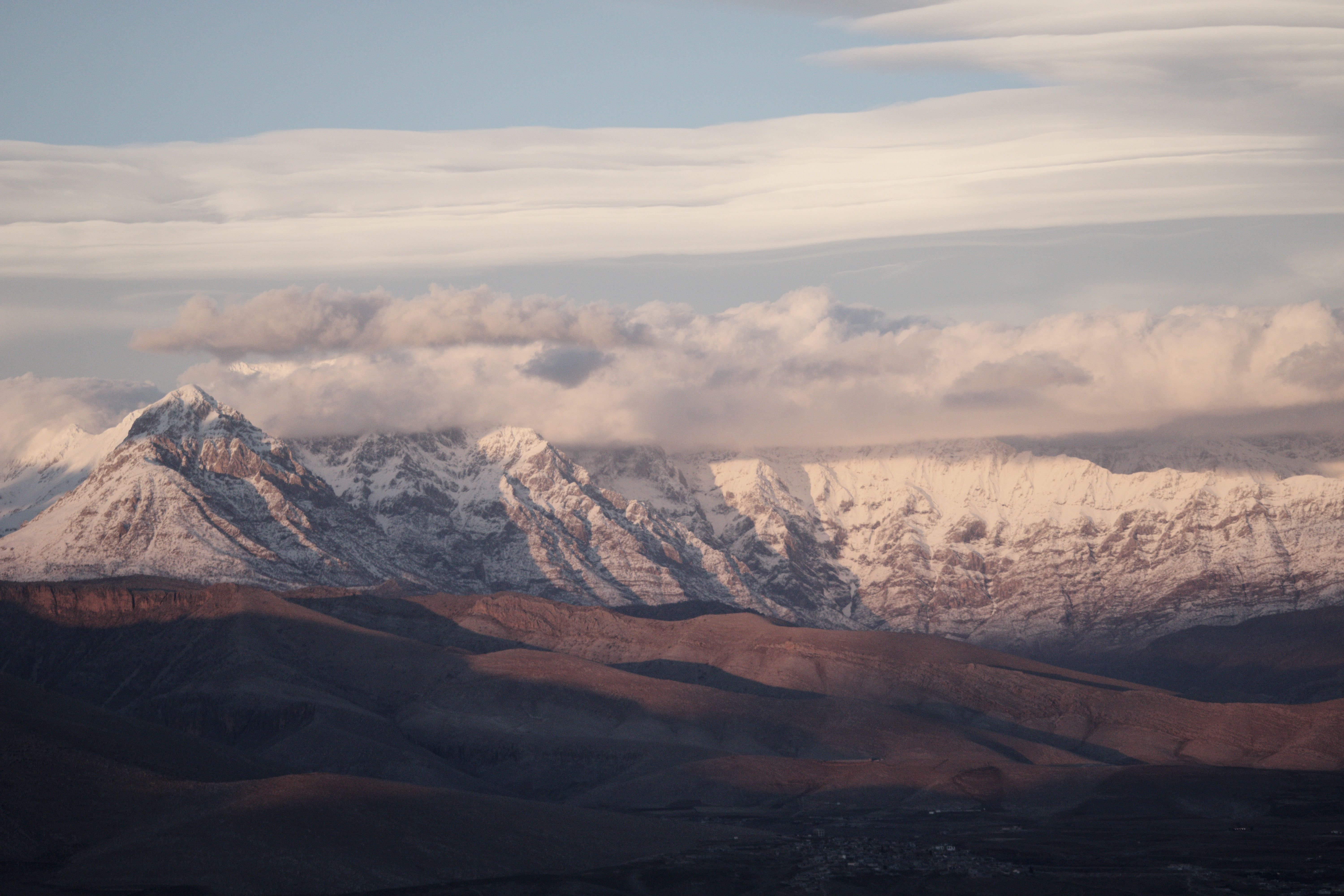 Snow Covered Mountains Under the Cloudy Sky · Free Stock Photo