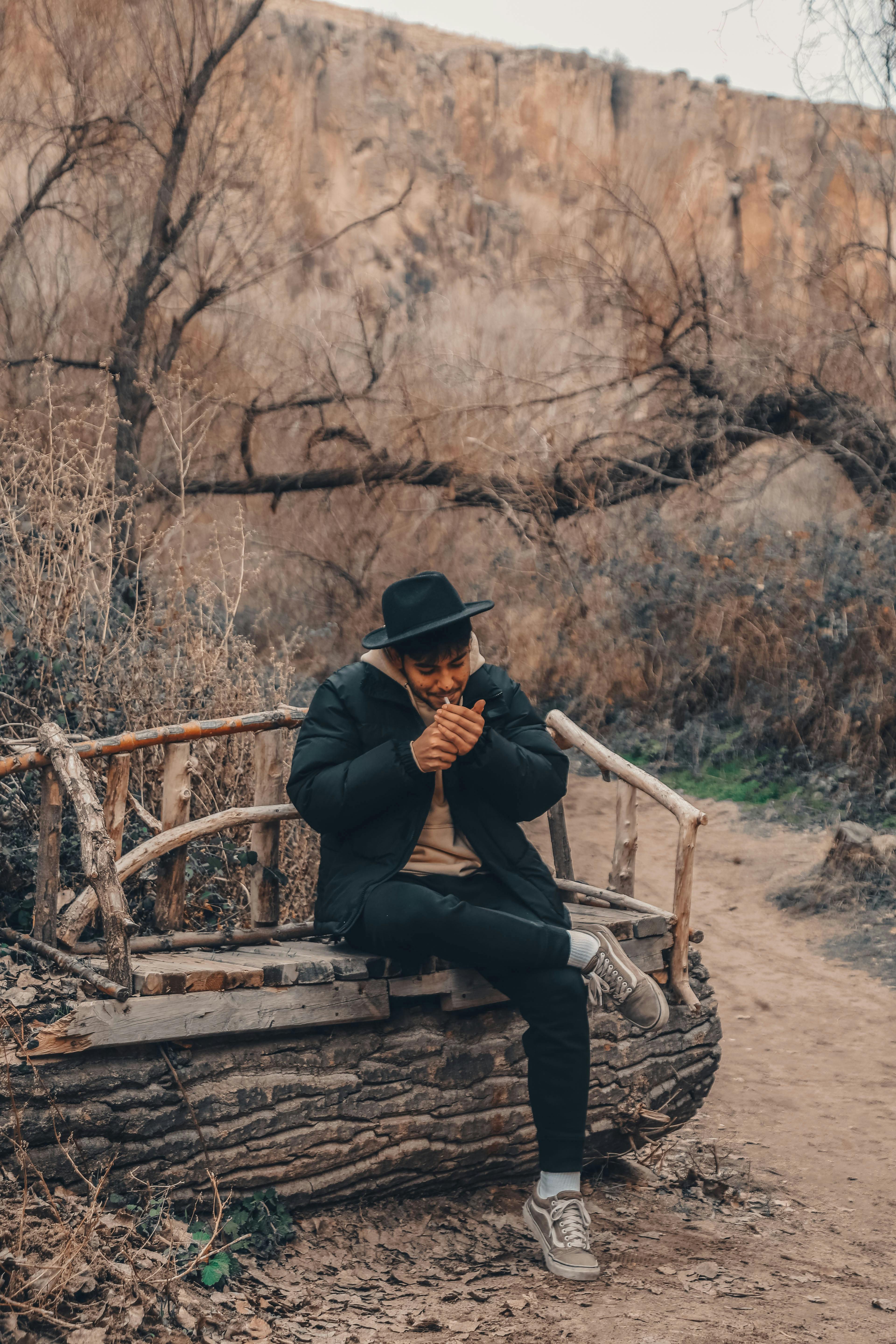 A Man Smoking while Sitting on a Bench · Free Stock Photo