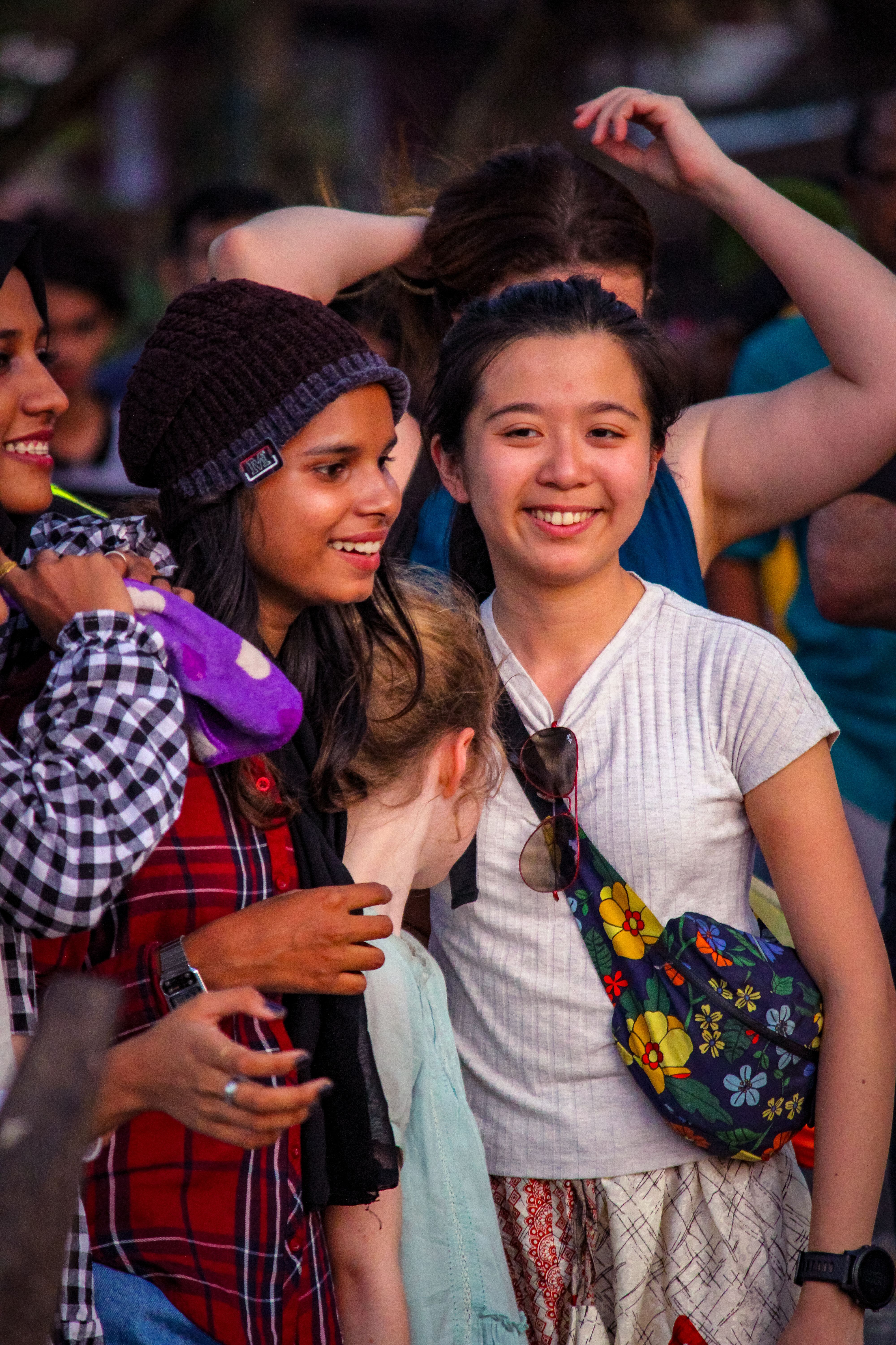 Smiling Girls Standing in a Crowd · Free Stock Photo